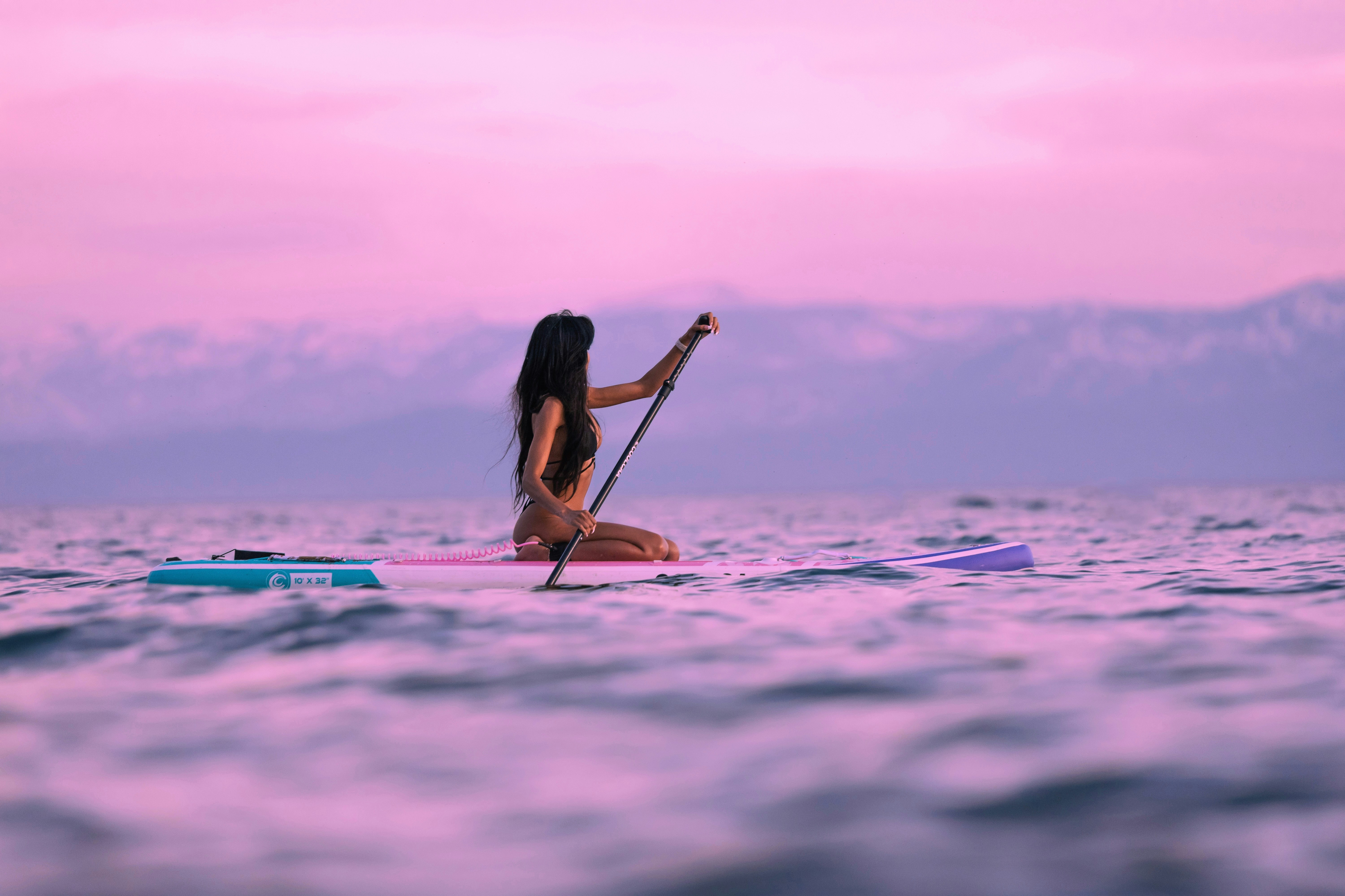 Pink Hour on the Water: A Solo Paddleboarder in Soft Dusk Light