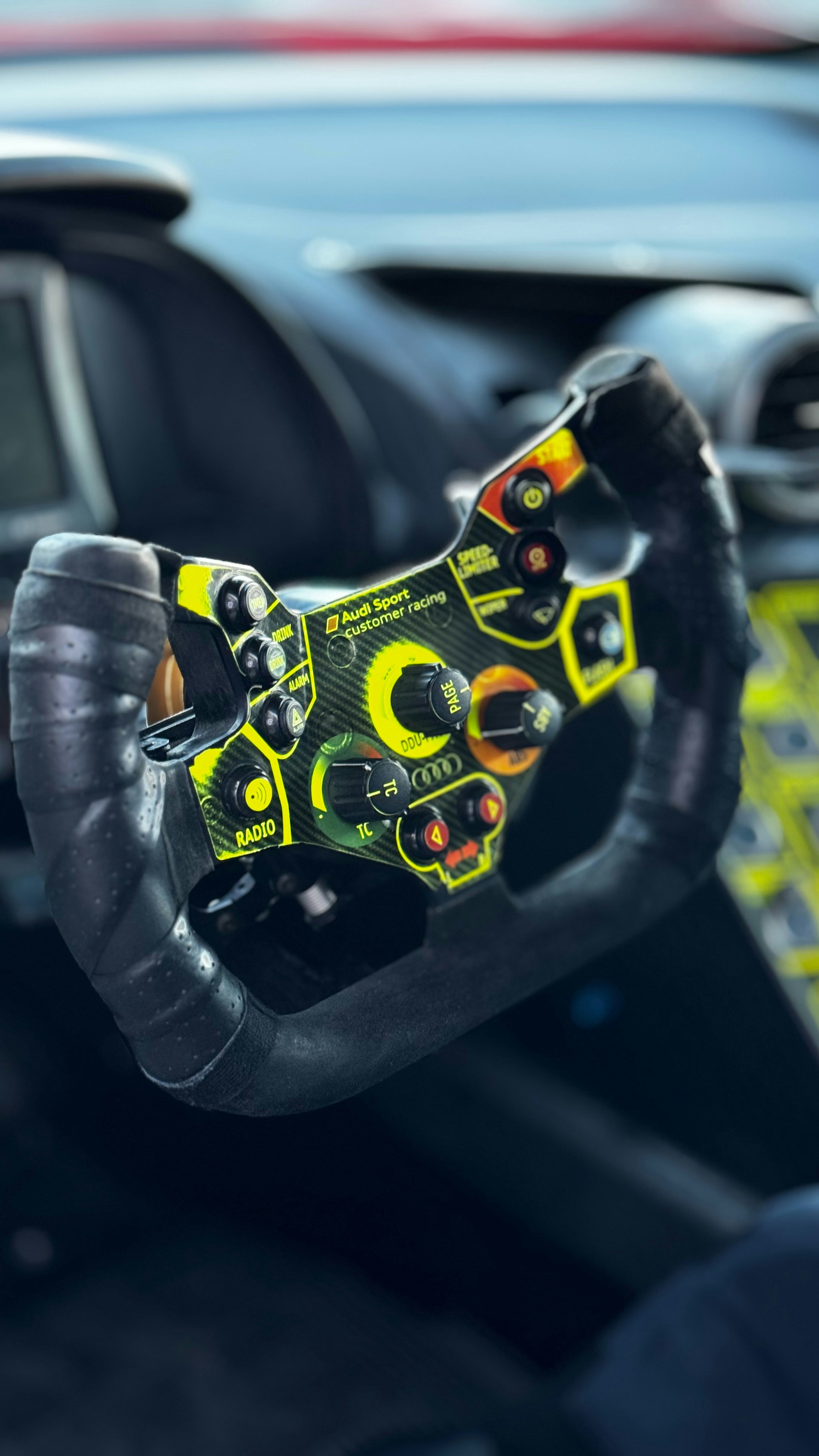 Close-Up Neon-Accented Rally Steering Wheel: A Cockpit's Intricate Control Lattice