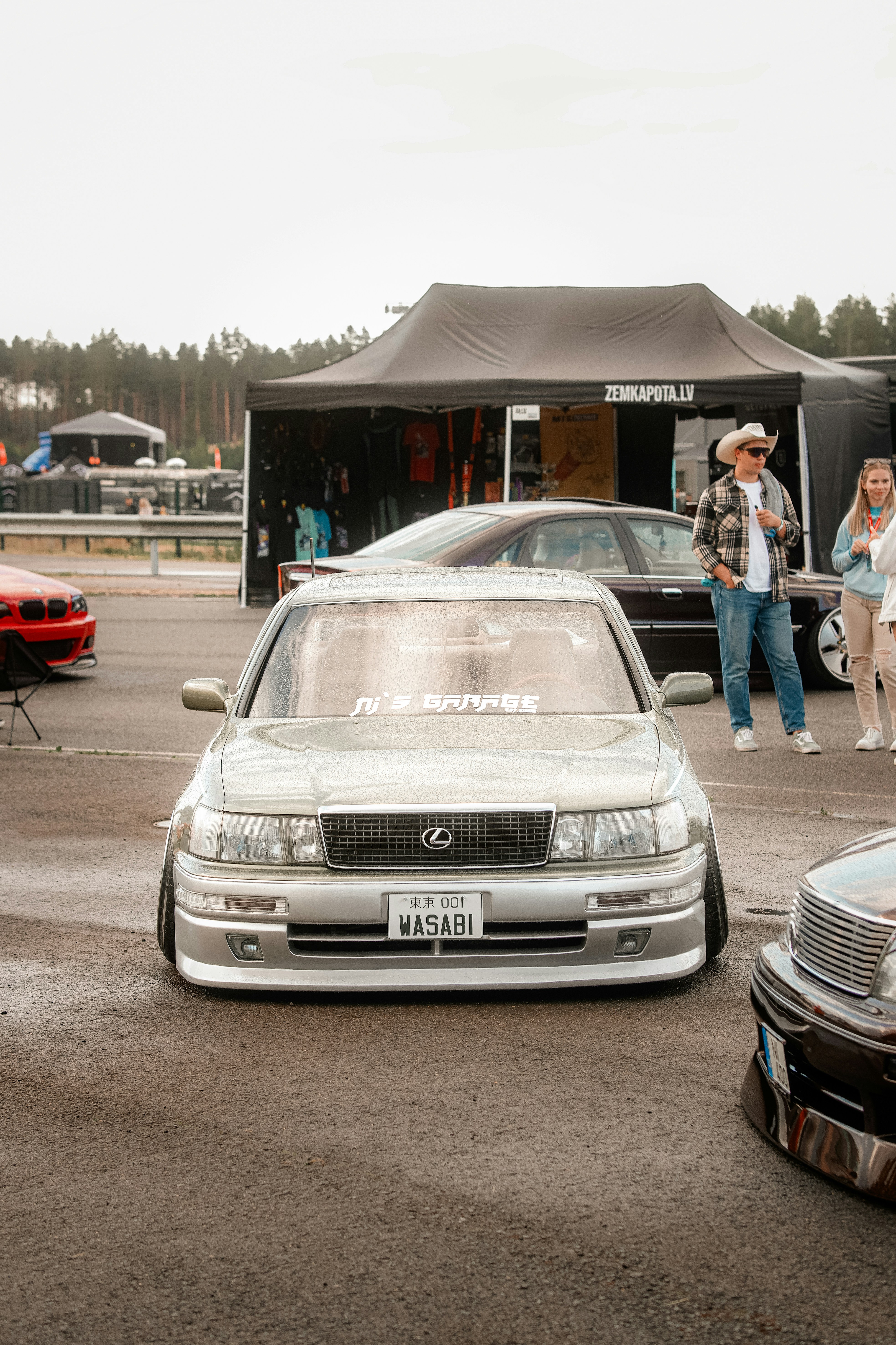 Wasabi in Focus: A Silver Lexus Holds Center at the Outdoor Car Show