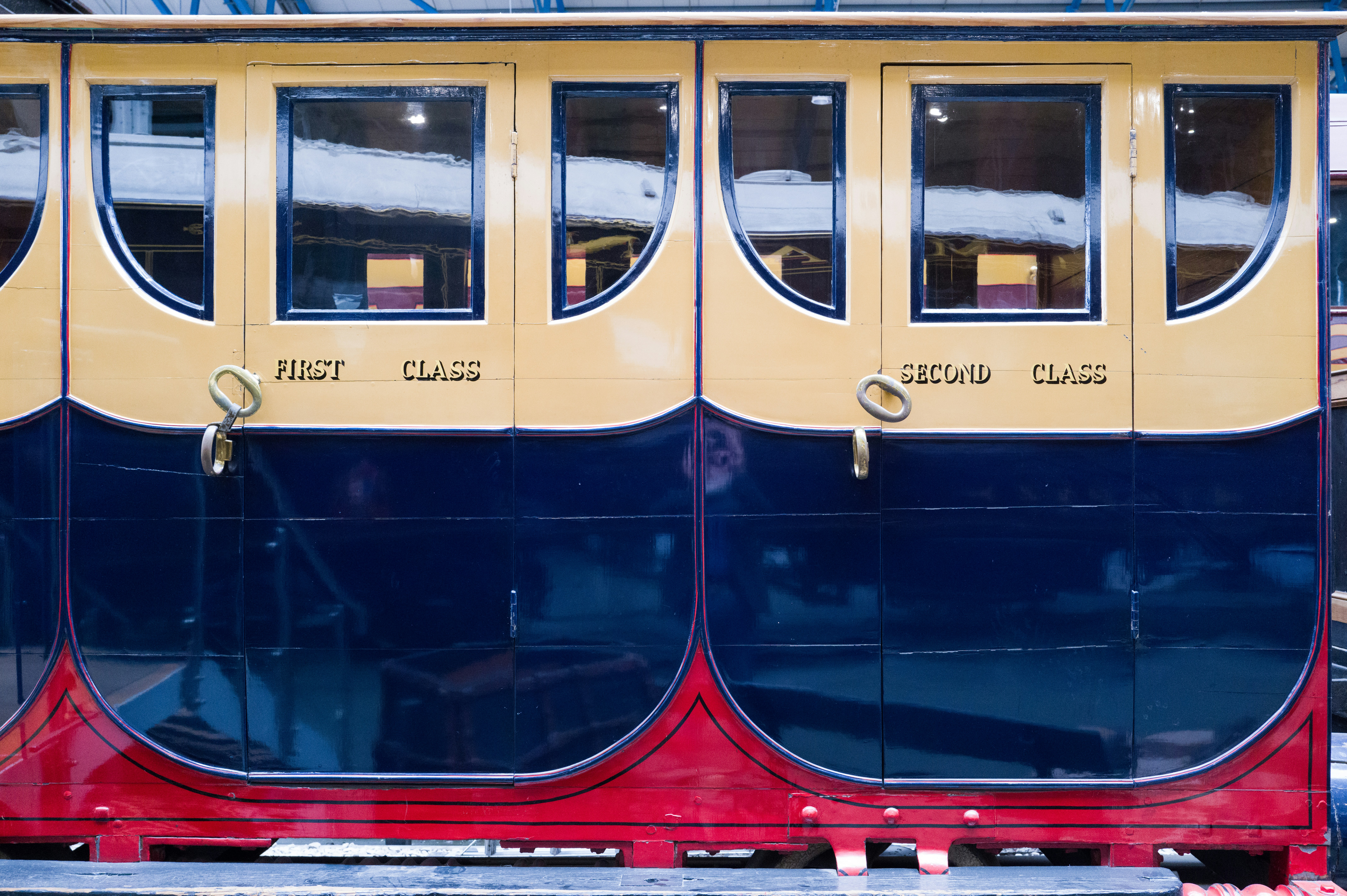 A blue and yellow train car sitting on the tracks photo – Free Museum ...