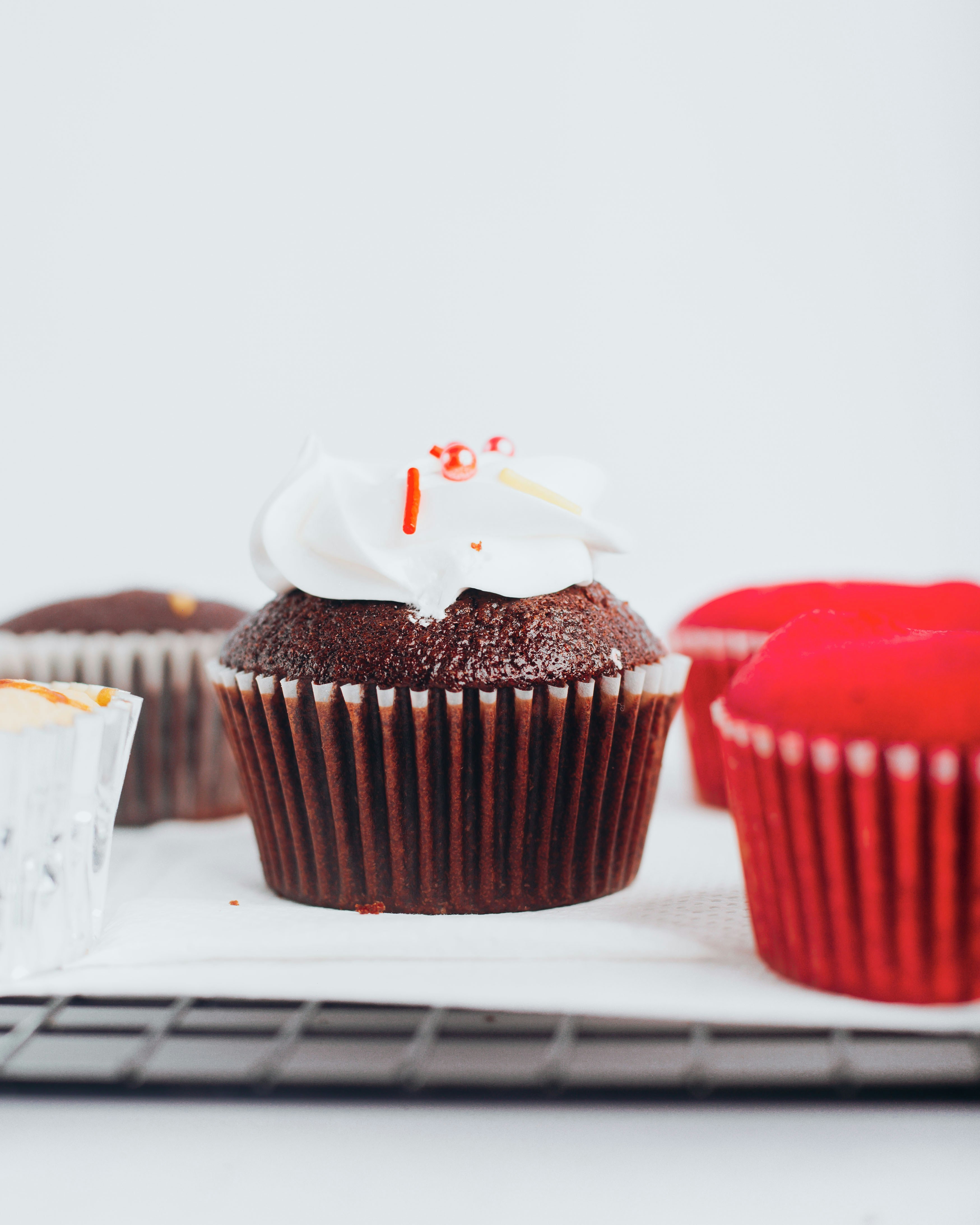 Centered Chocolate Cupcake with White Frosting on a Cooling Rack