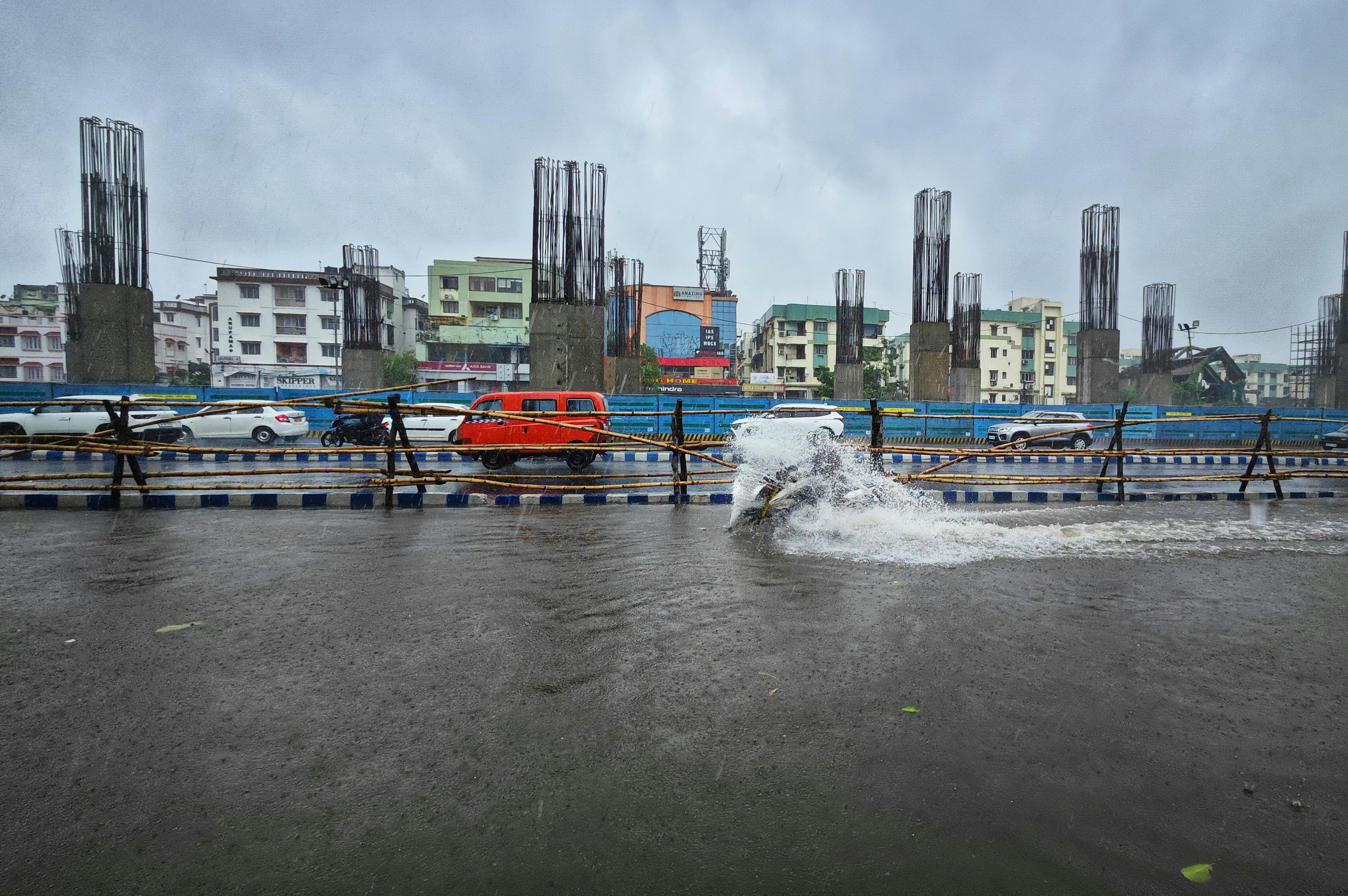 A fire hydrant spewing water on a city street photo – Free Water Image ...