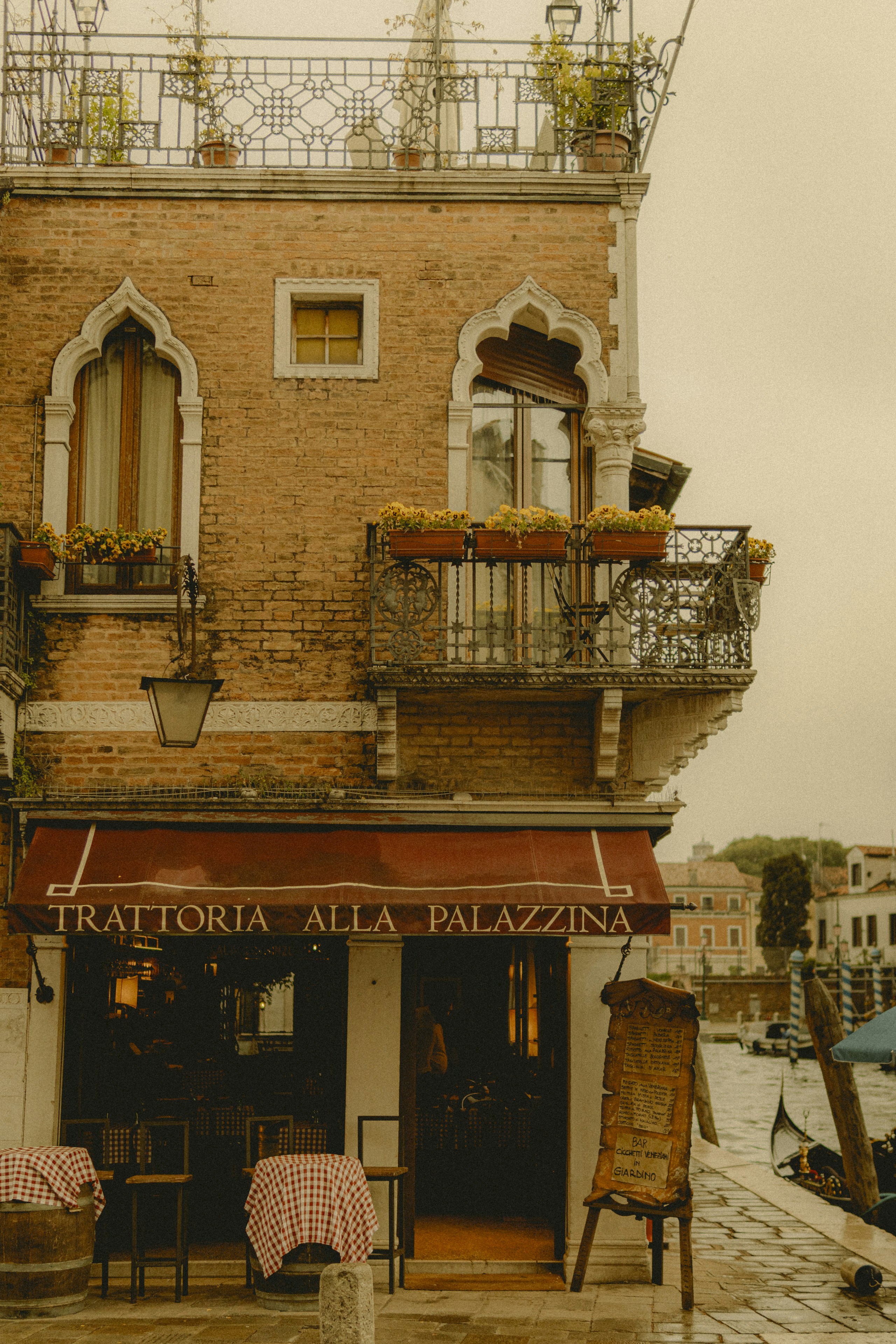 Veranda on the Canal: Arched Brick Facade at Trattoria Alla Palazzina