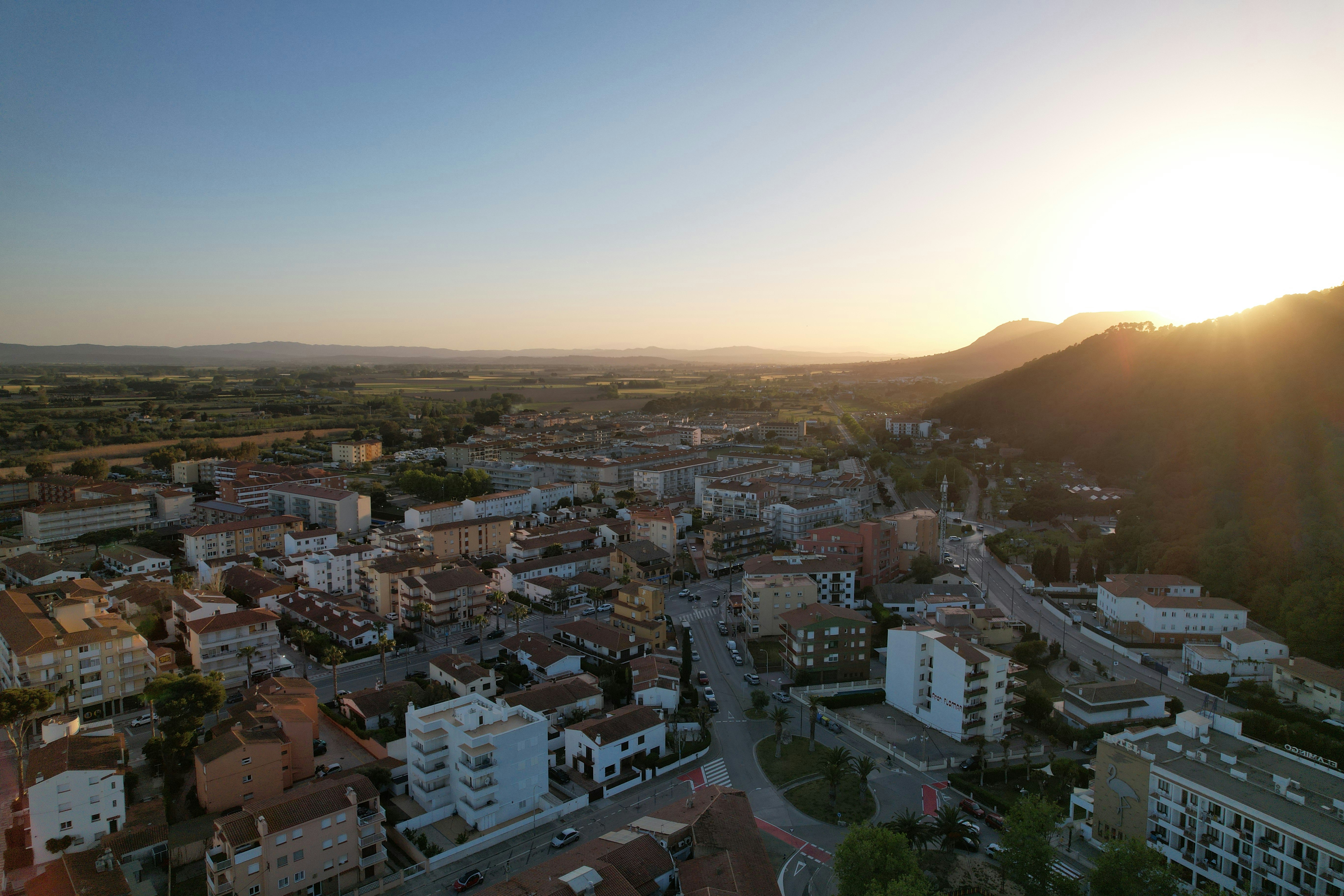Dusk Over the Ridge: A Quiet Town Bathed in Golden Light