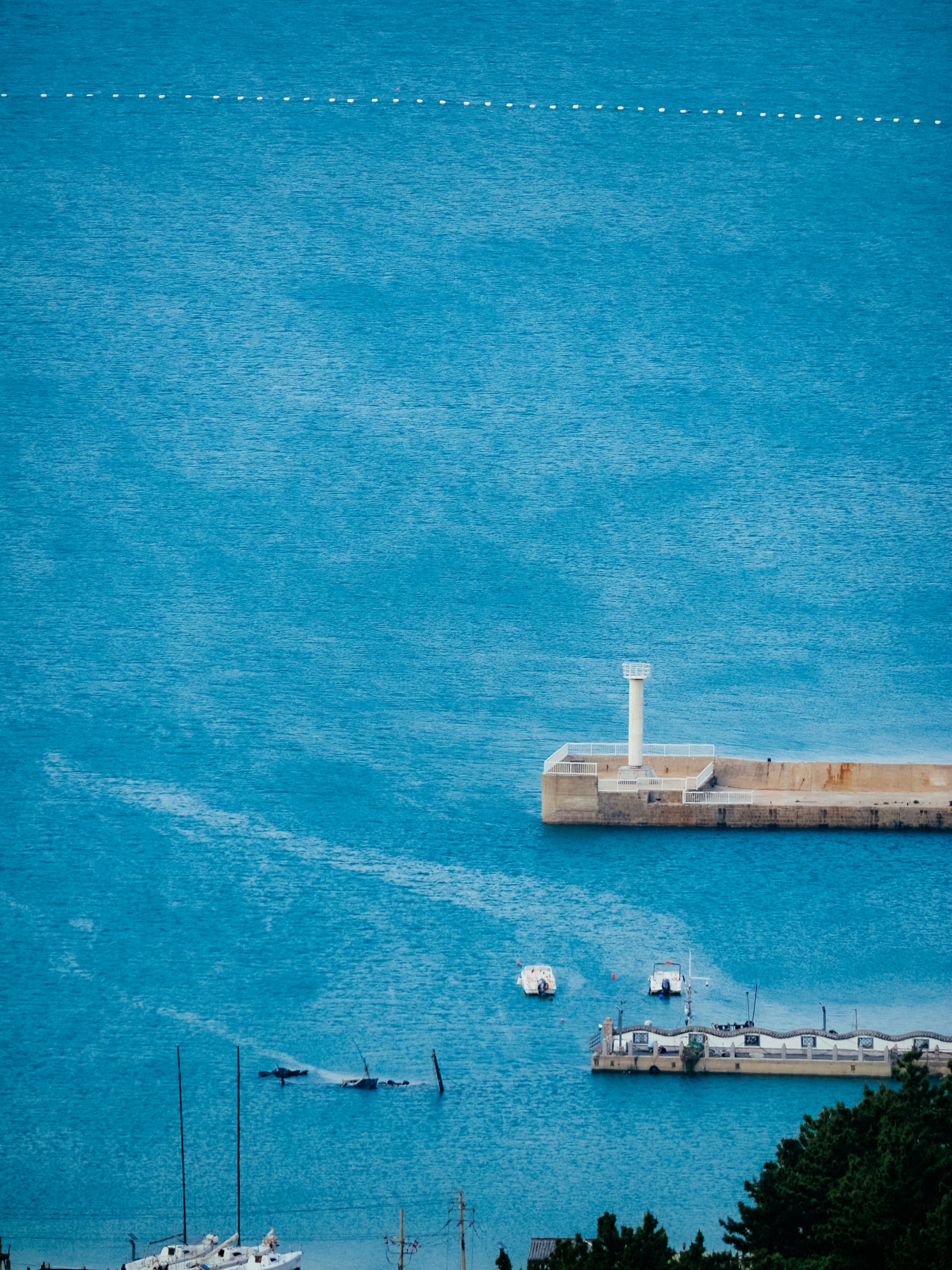 Azure Harbor Pier: A Quiet Concrete Span Reaching into Velvet Blue Water