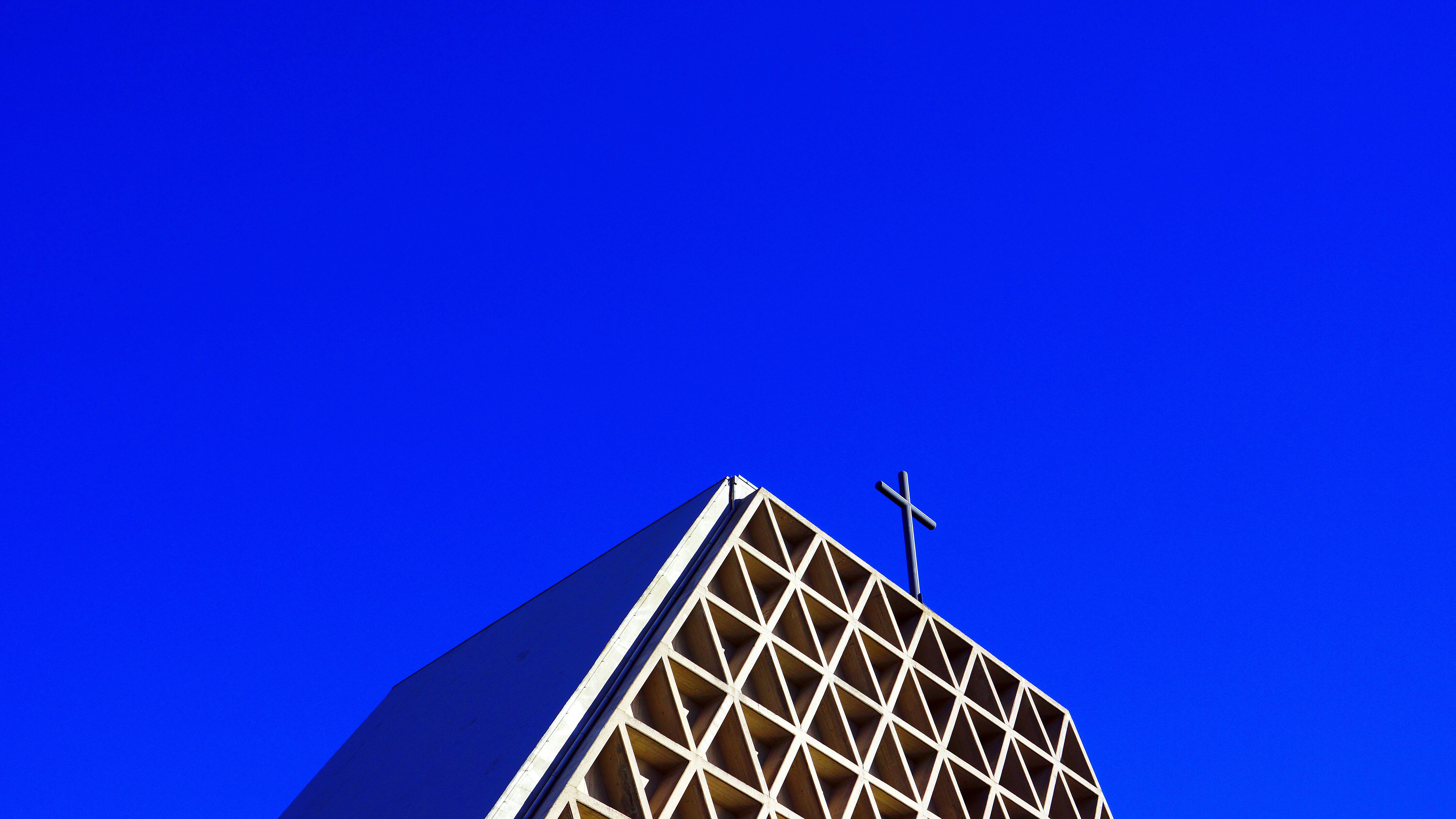 A tall building with a cross on top of it photo – Free Office building ...