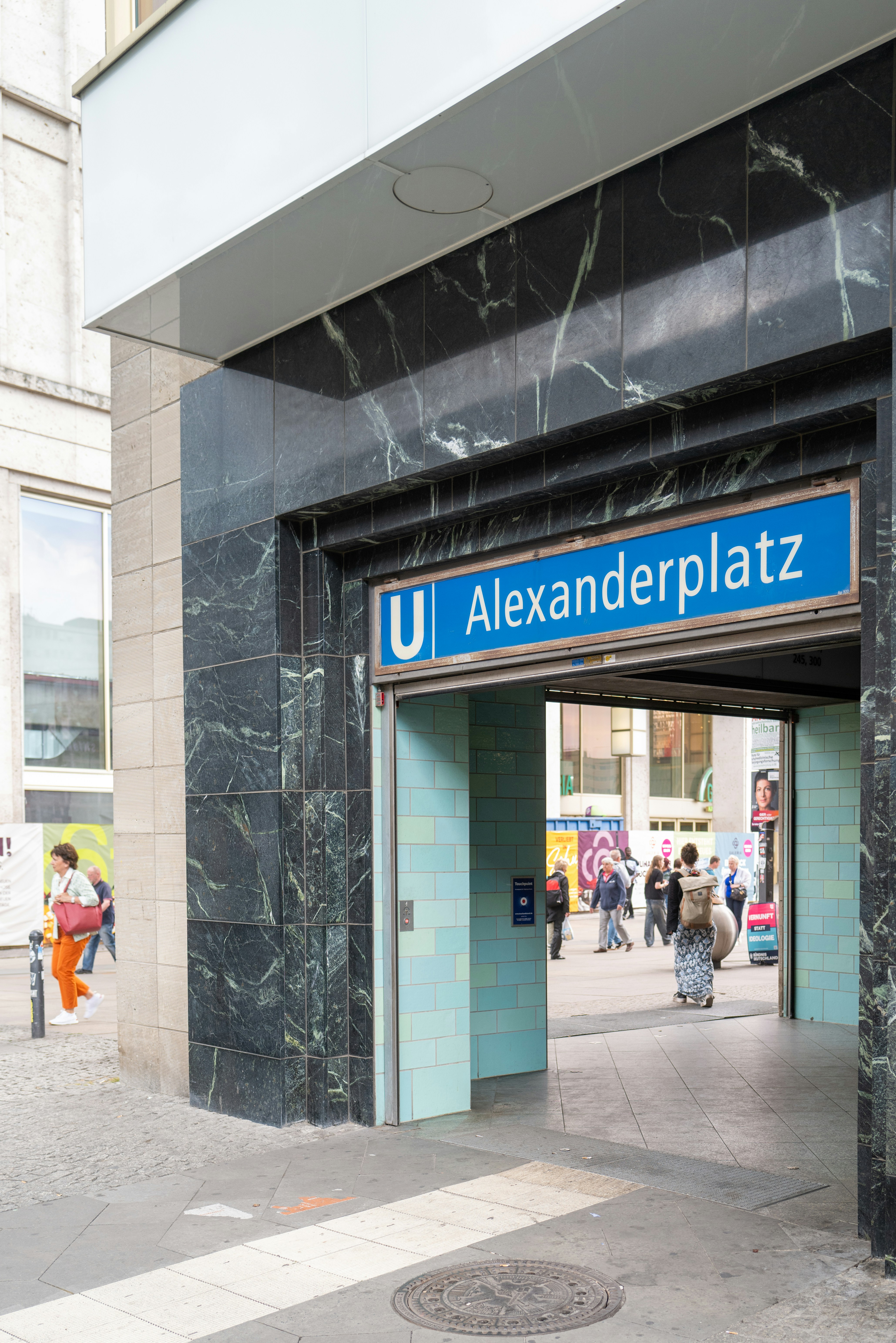 Blue U Gate at Alexanderplatz: Marble Frame and Busy Berlin Entrance