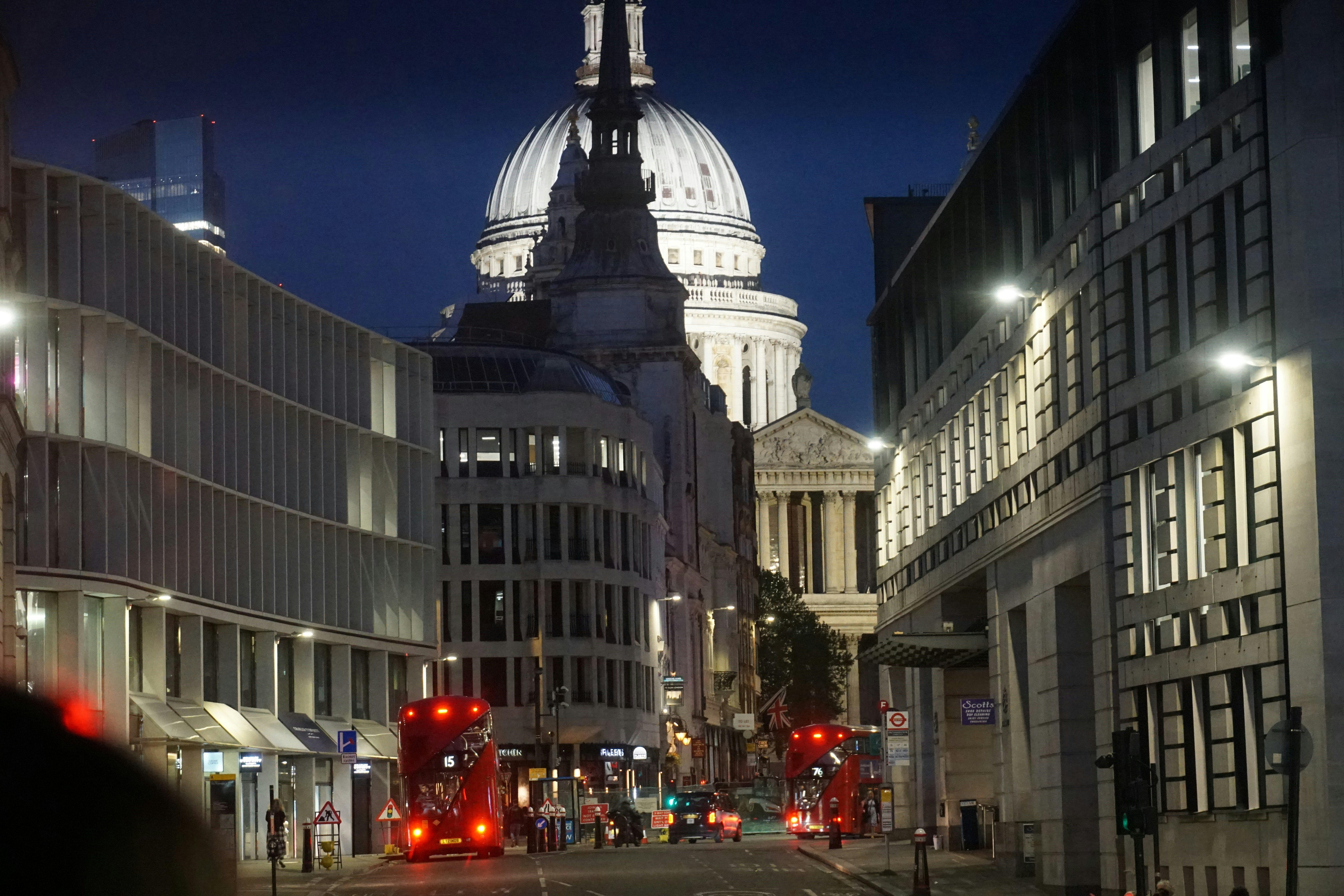 St Pauls Cathedral at night | a city street at night with a dome in the background