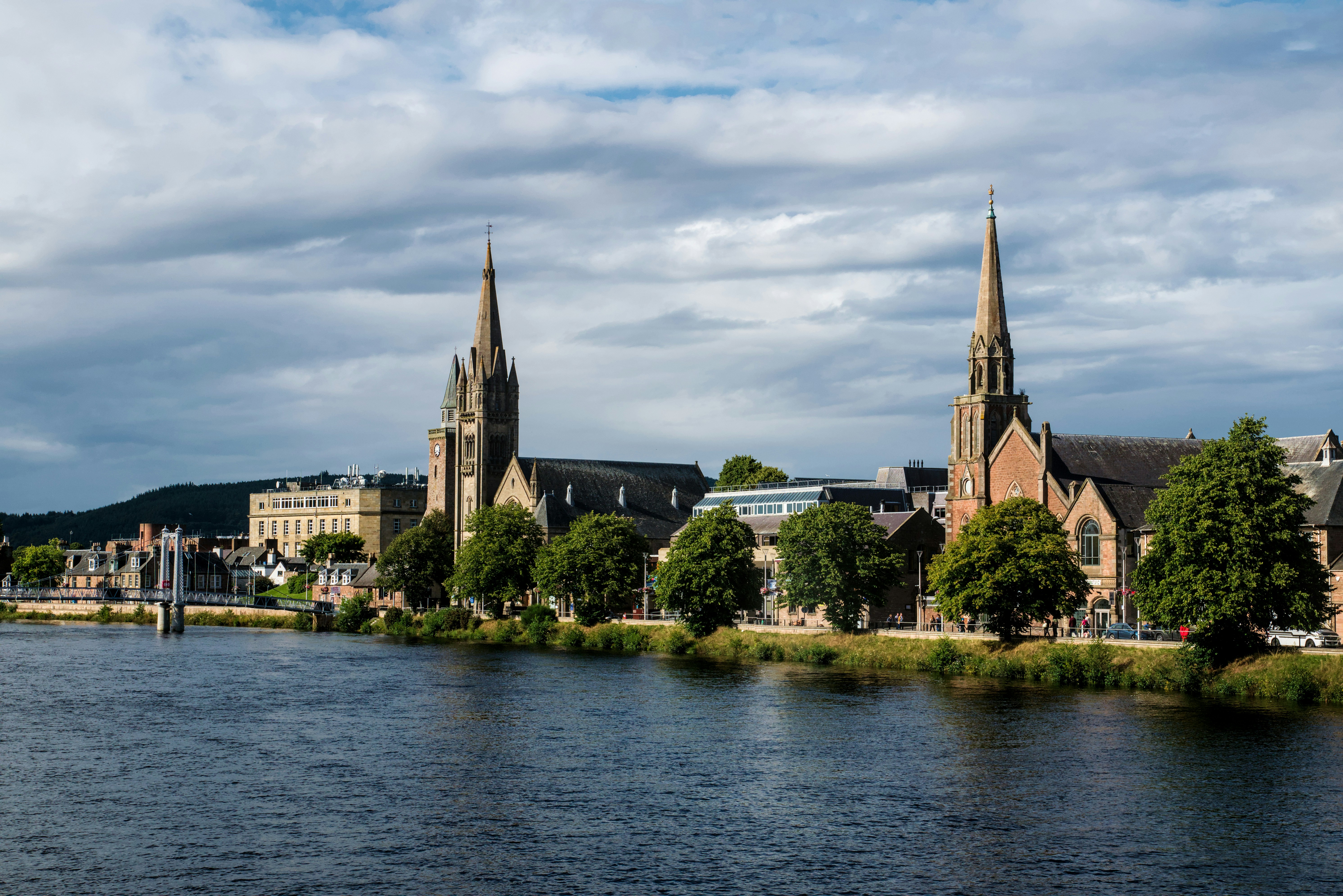 A river running through a city next to tall buildings photo – Free ...