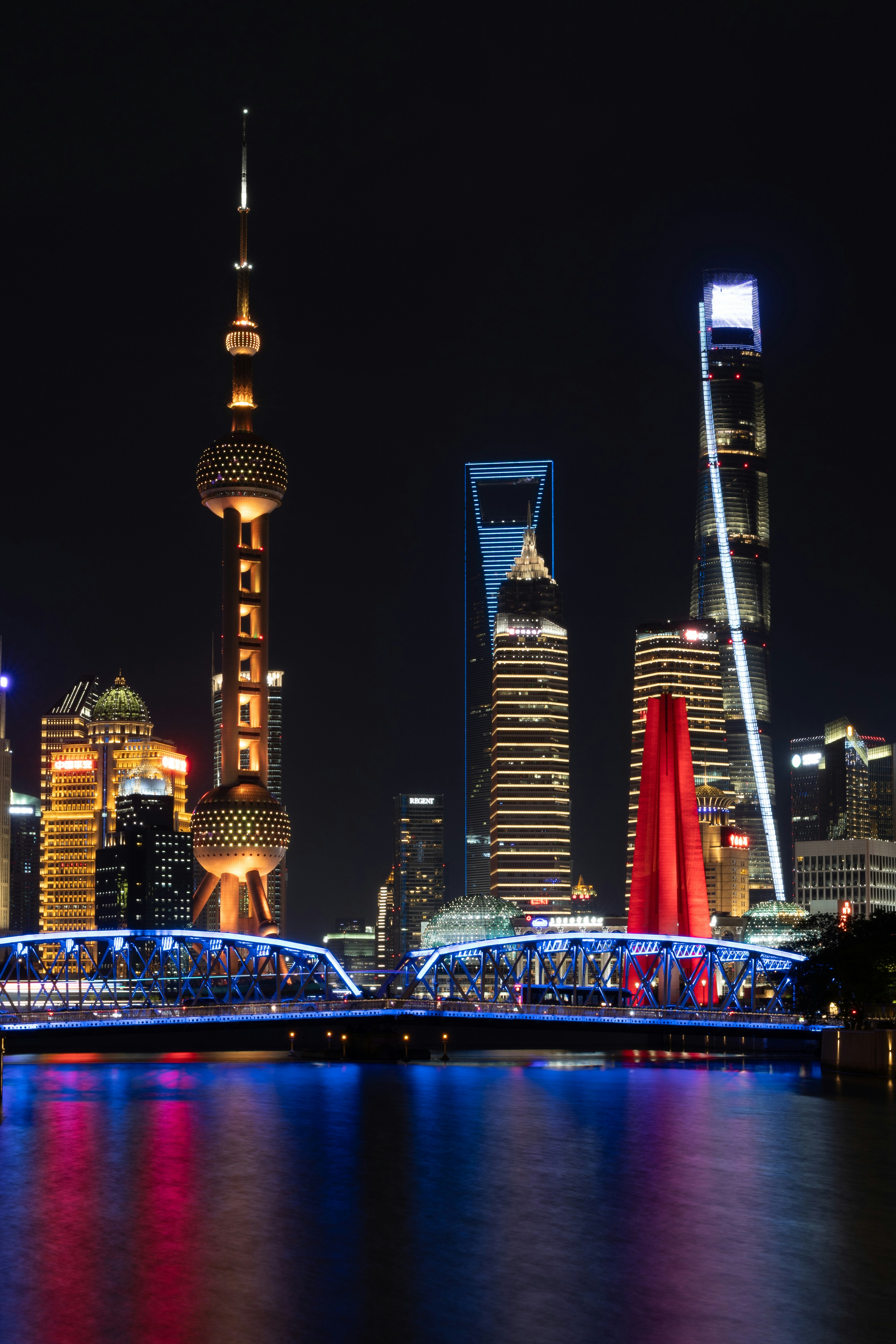 Neon Skyline over Shanghai: Oriental Pearl Tower Among Glass Giants at Night