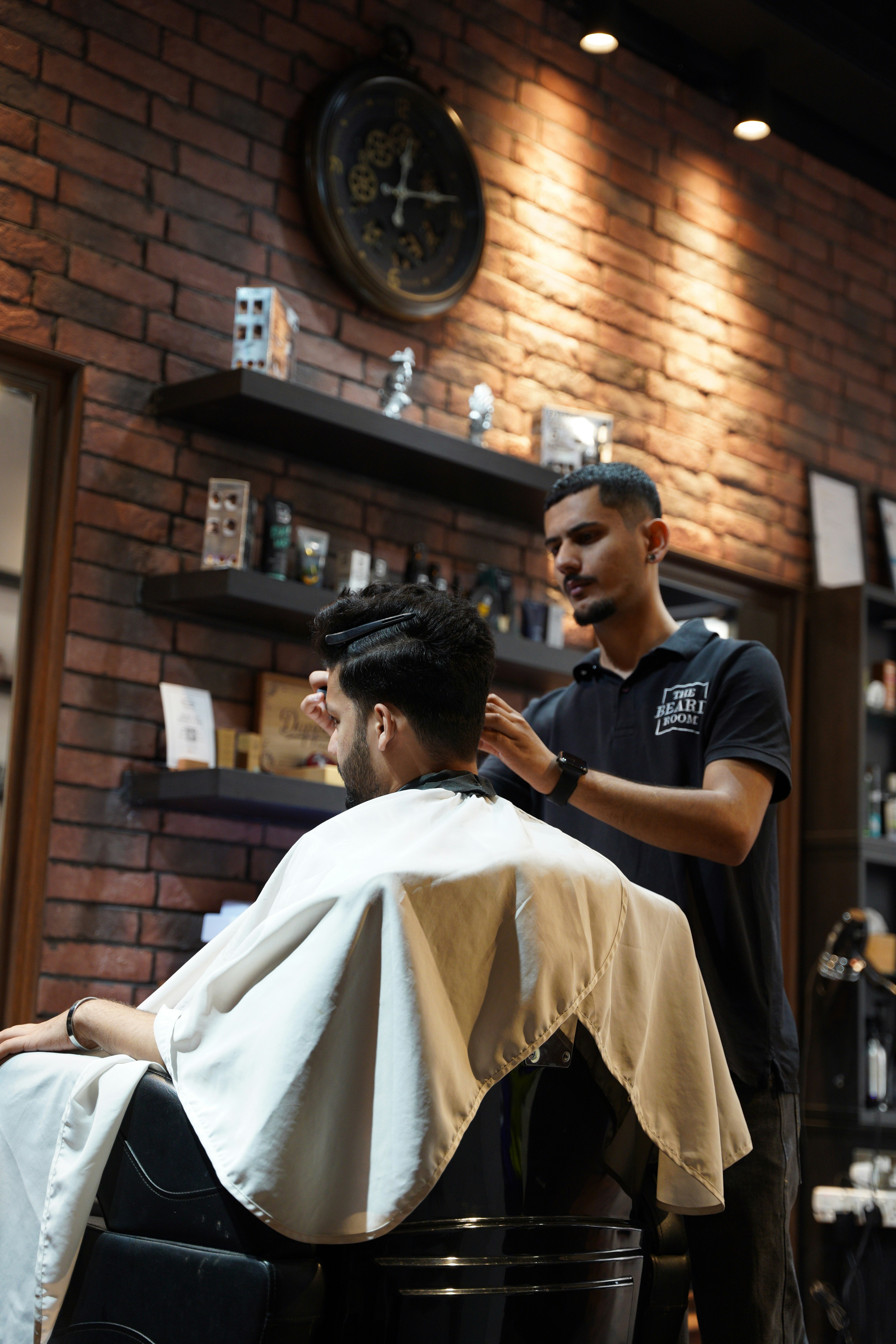 A man getting his hair cut at a barber shop photo – Free Uae - dubai ...