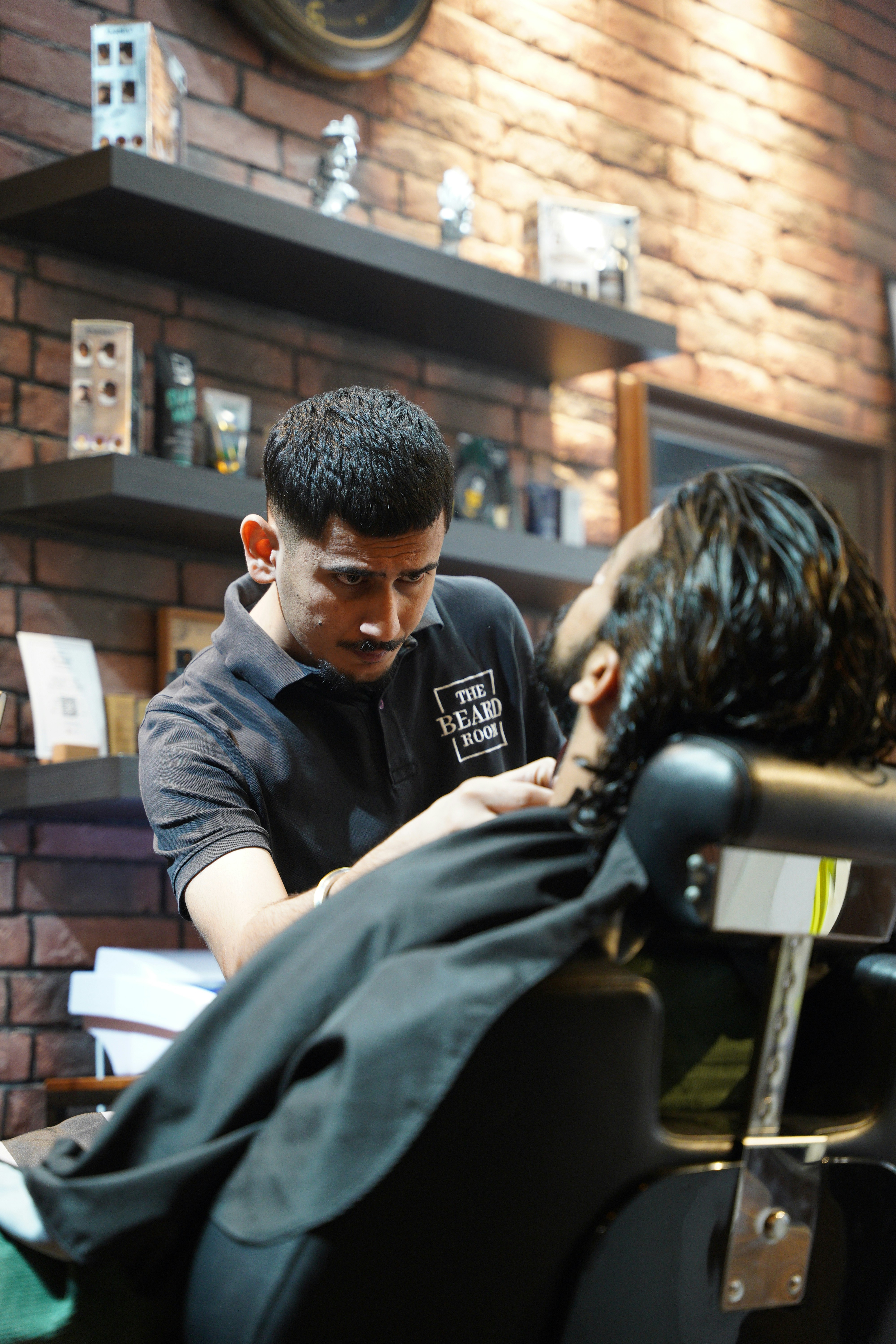 A man getting his hair cut at a barber shop photo – Free Uae - dubai ...