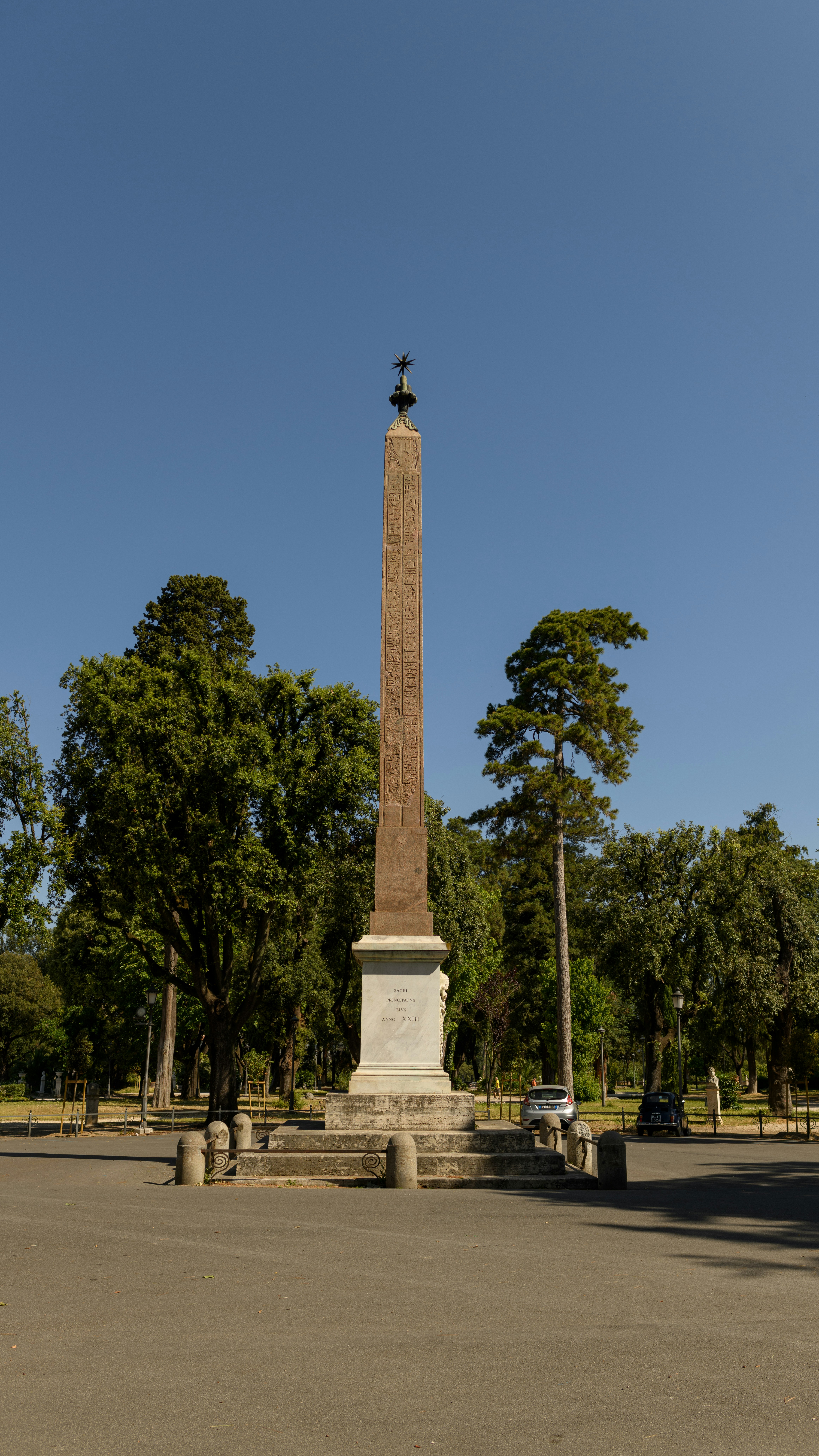 Obelisk Rising: A Park Monument Standing Against a Clear Summer Sky