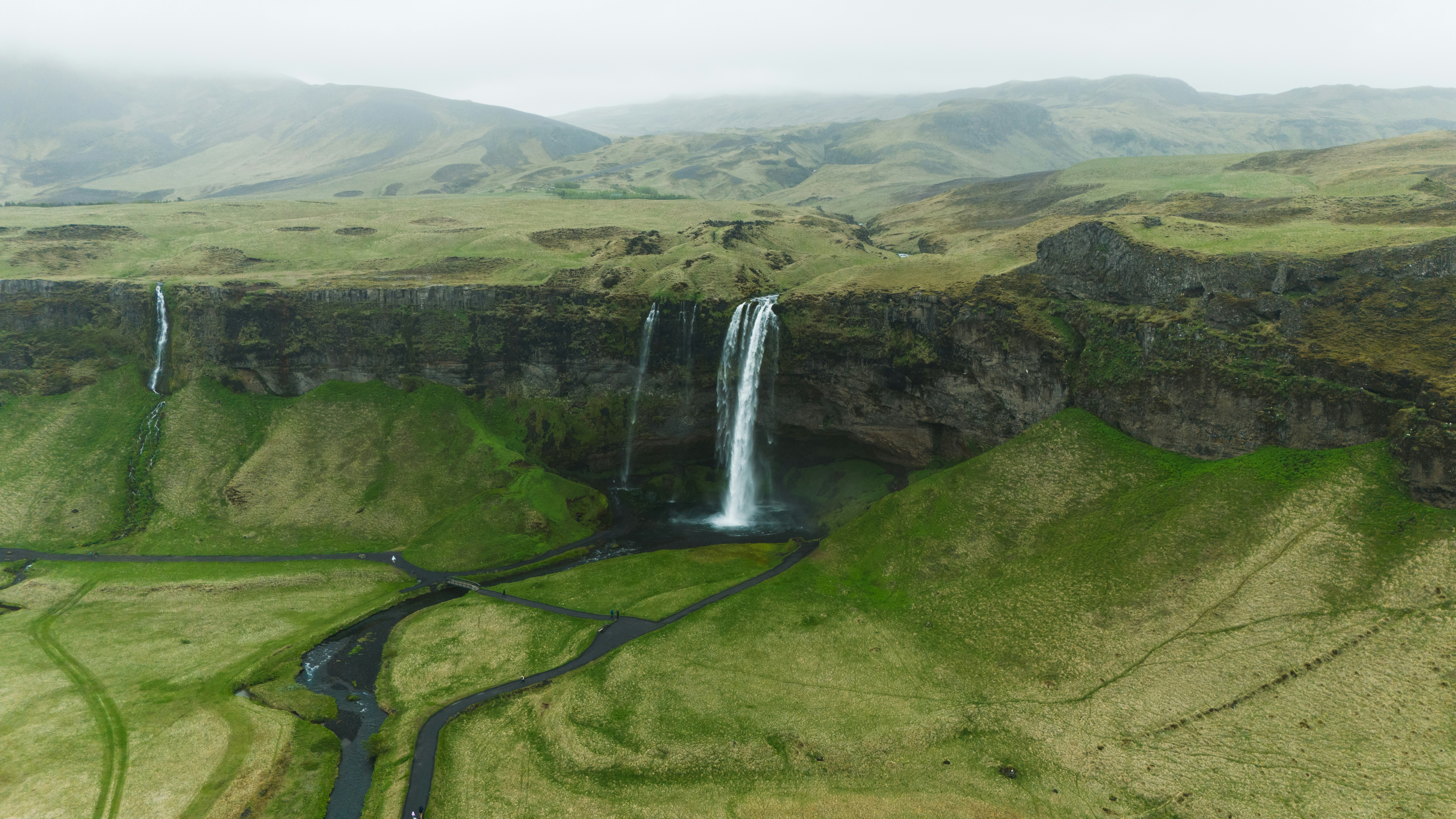 An aerial view of a waterfall in the mountains photo – Free Nature ...