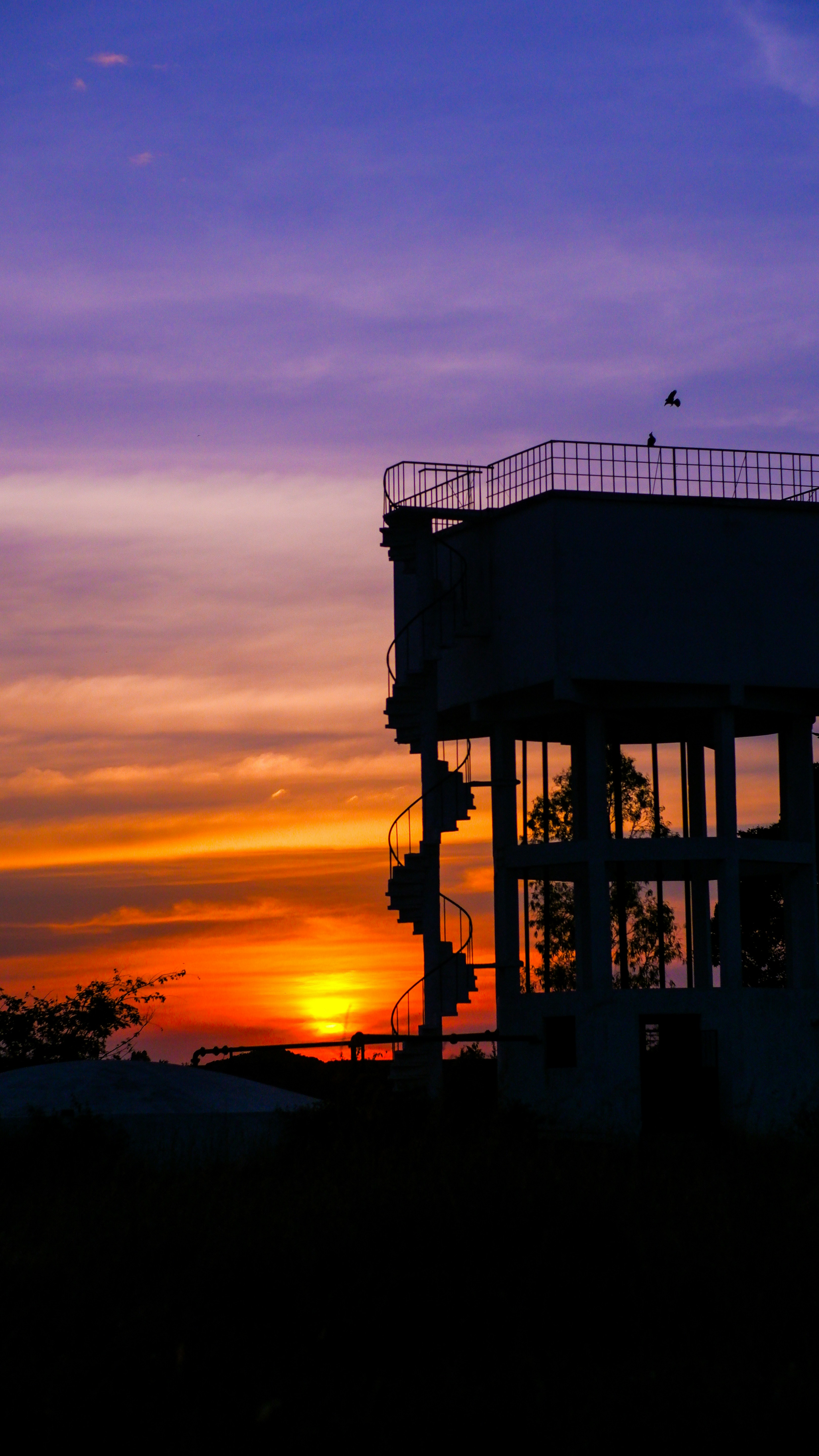 Sunset Overlook: silhouette of a staircase tower against a painted sky