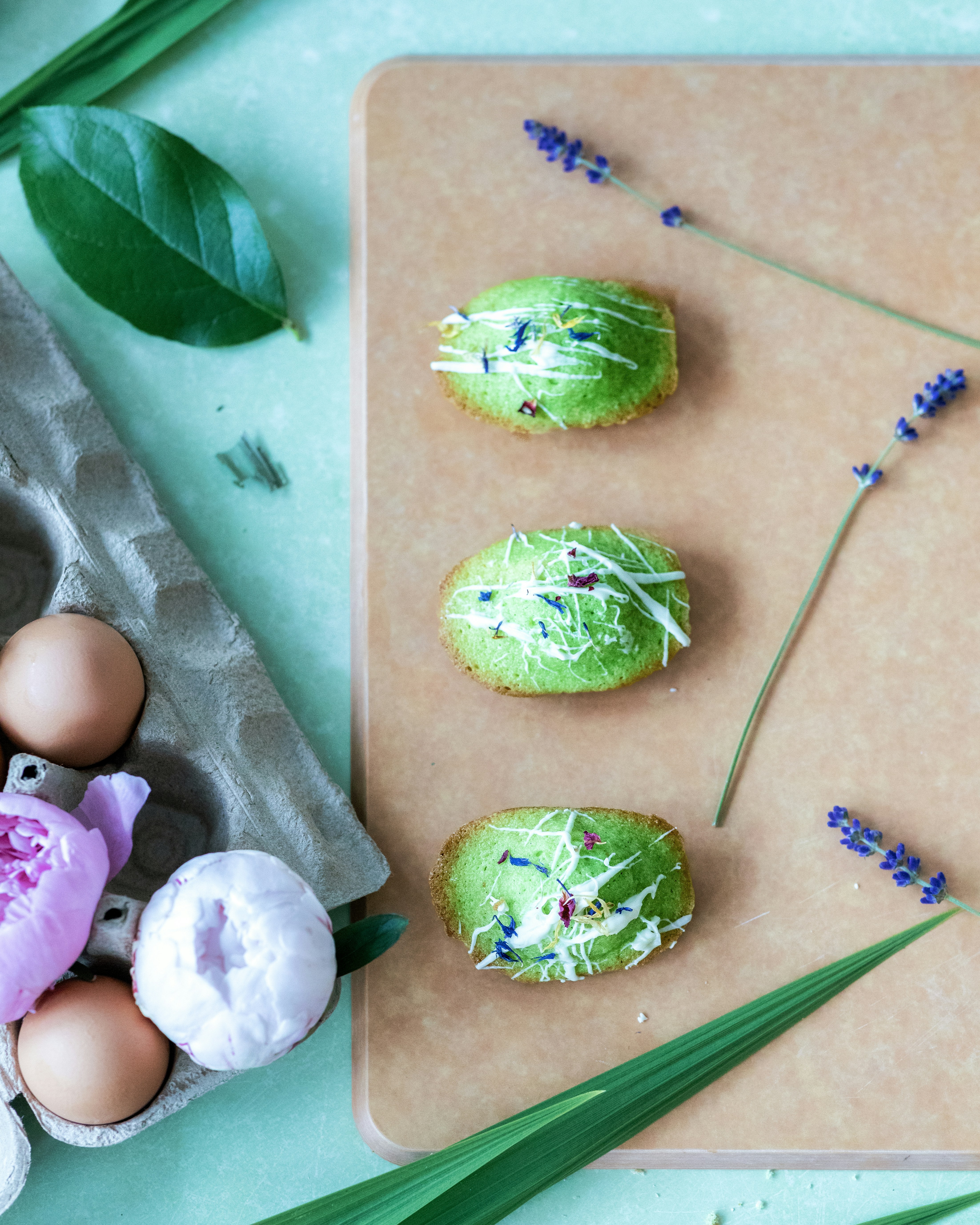 Green macaron trio: herb-filled bites on a lavender-sprig board