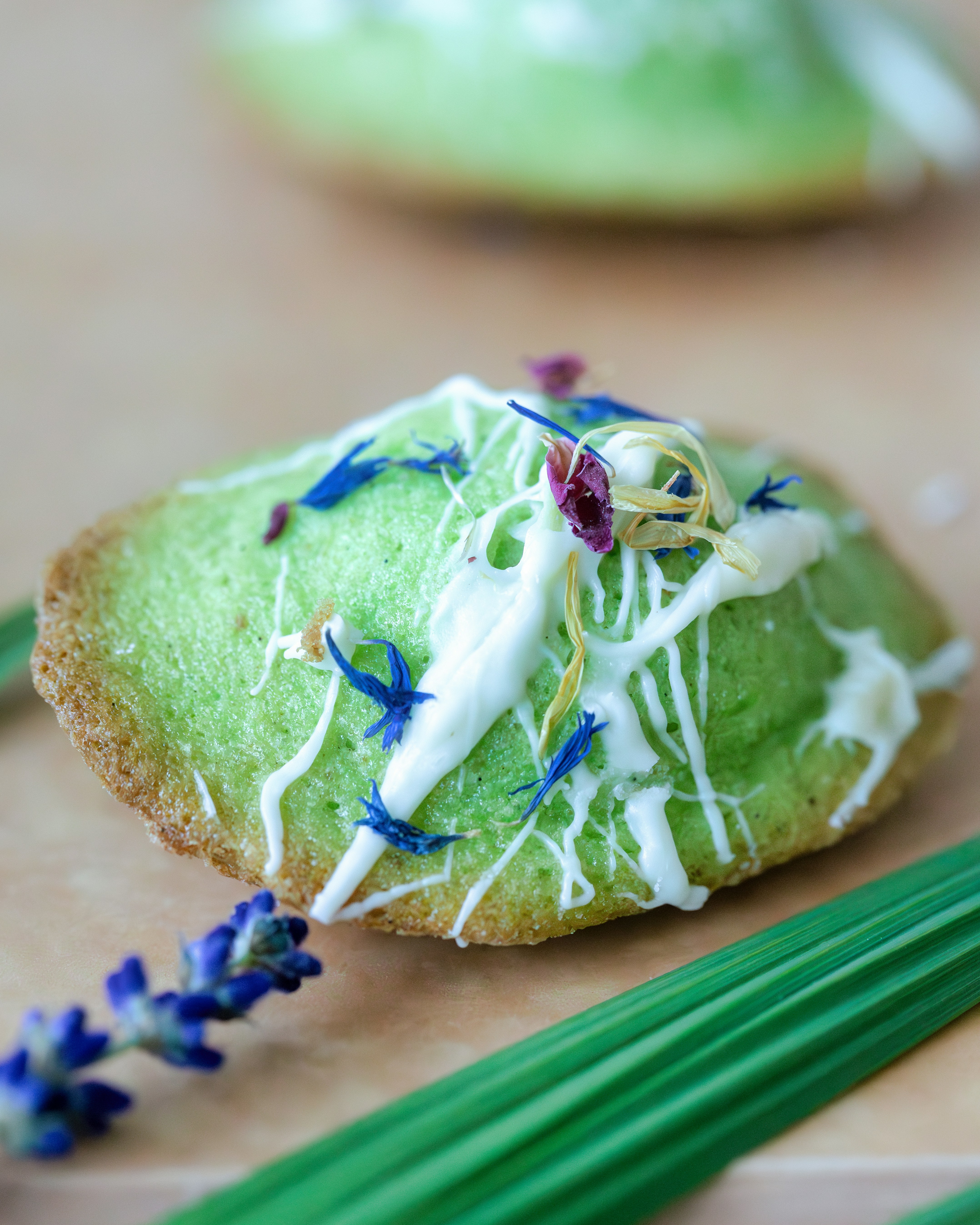 A green pastry with white icing and blue flowers photo – Free Sweets ...