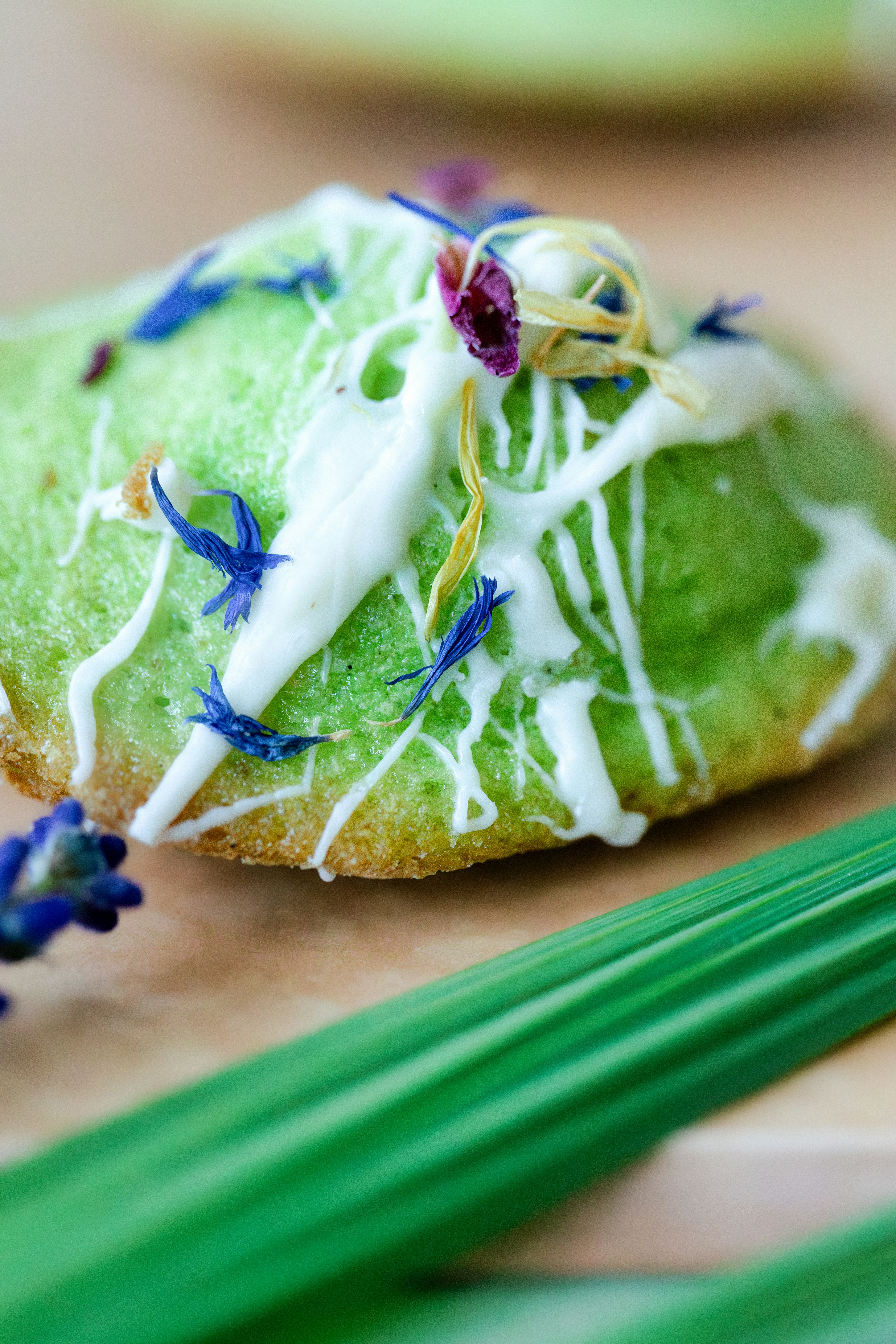 A green pastry with white icing and blue flowers photo – Free Sweets ...