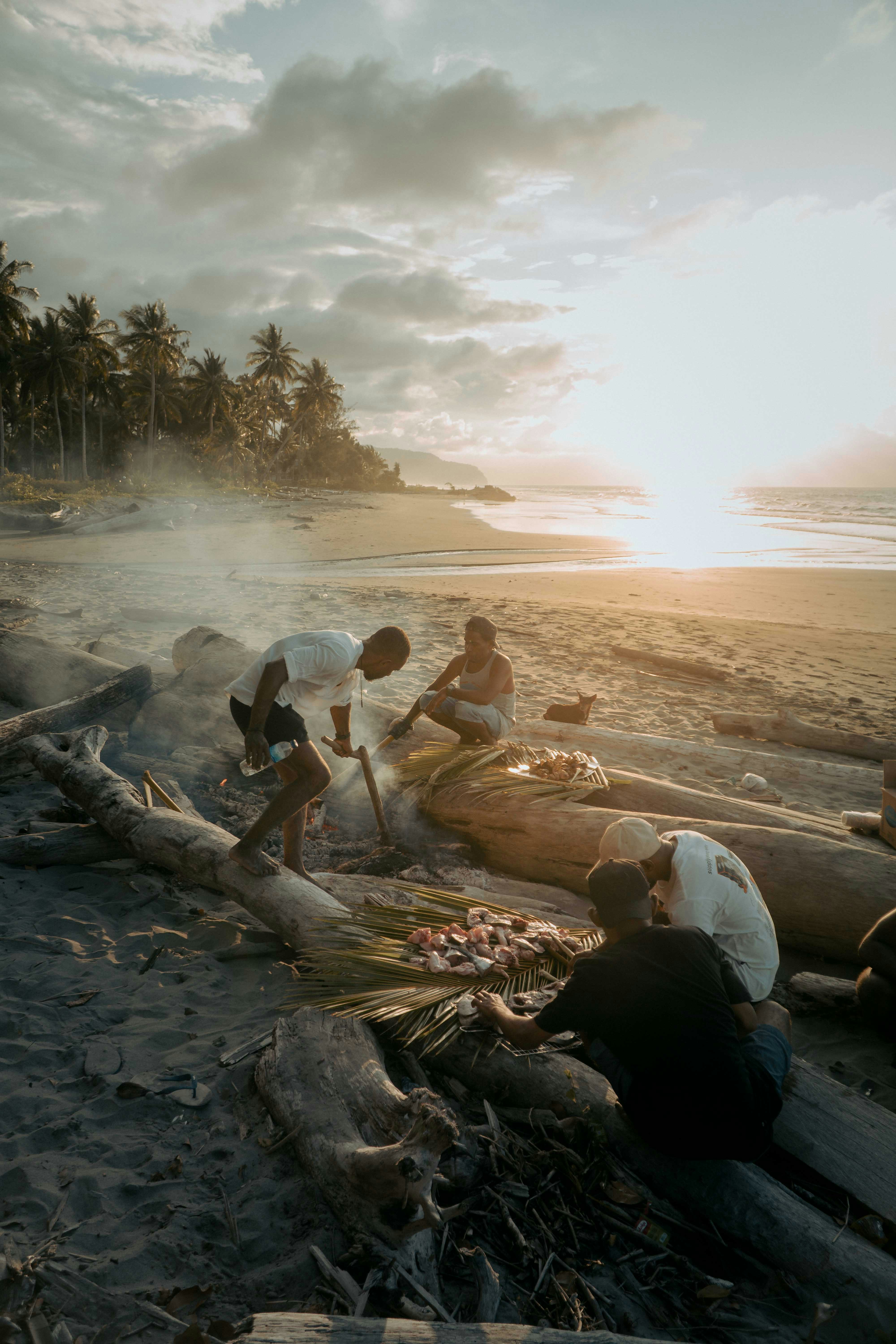 A group of people sitting on top of a beach photo – Free Skow yambe ...