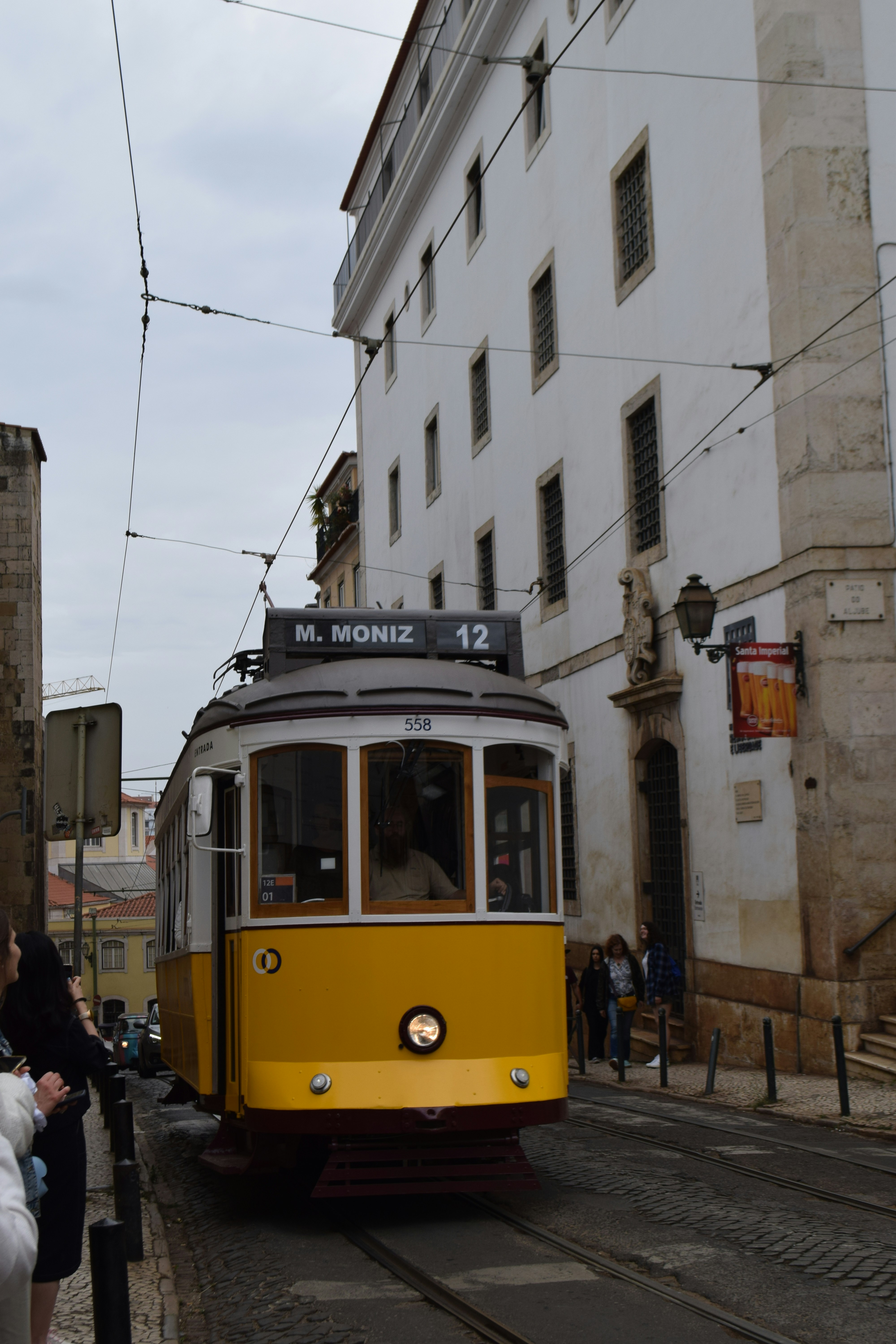 Yellow Tram Commute Under a Historic Lisbon Facade