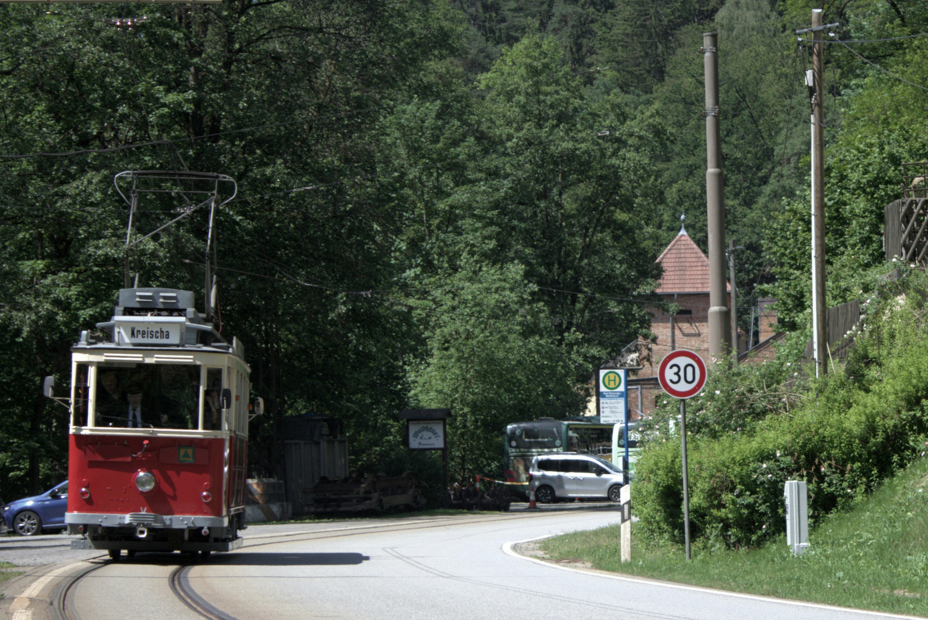 A red trolly car traveling down a curvy road photo – Free Road Image on ...