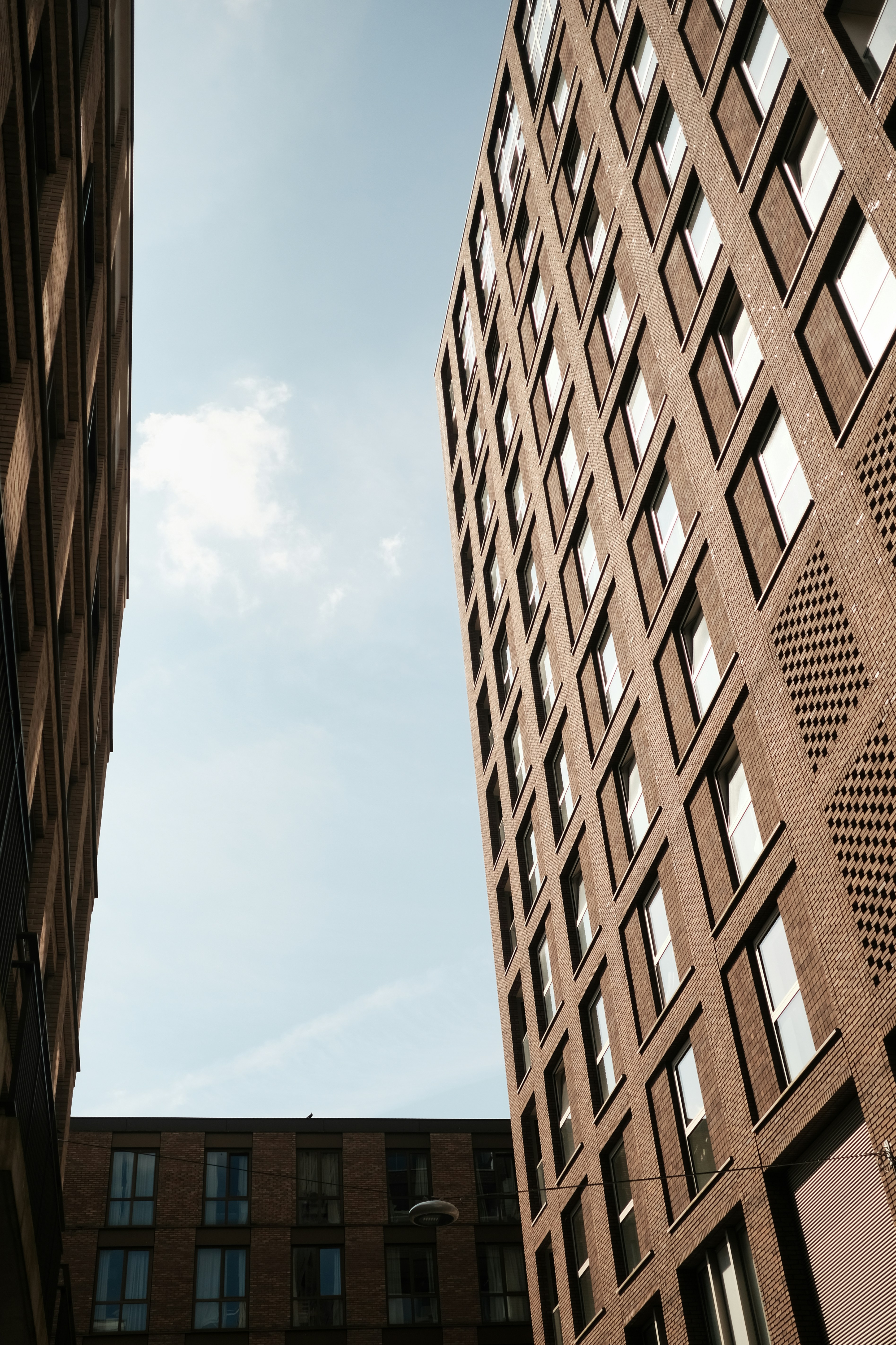 A couple of tall buildings next to each other photo – Free Amsterdam ...