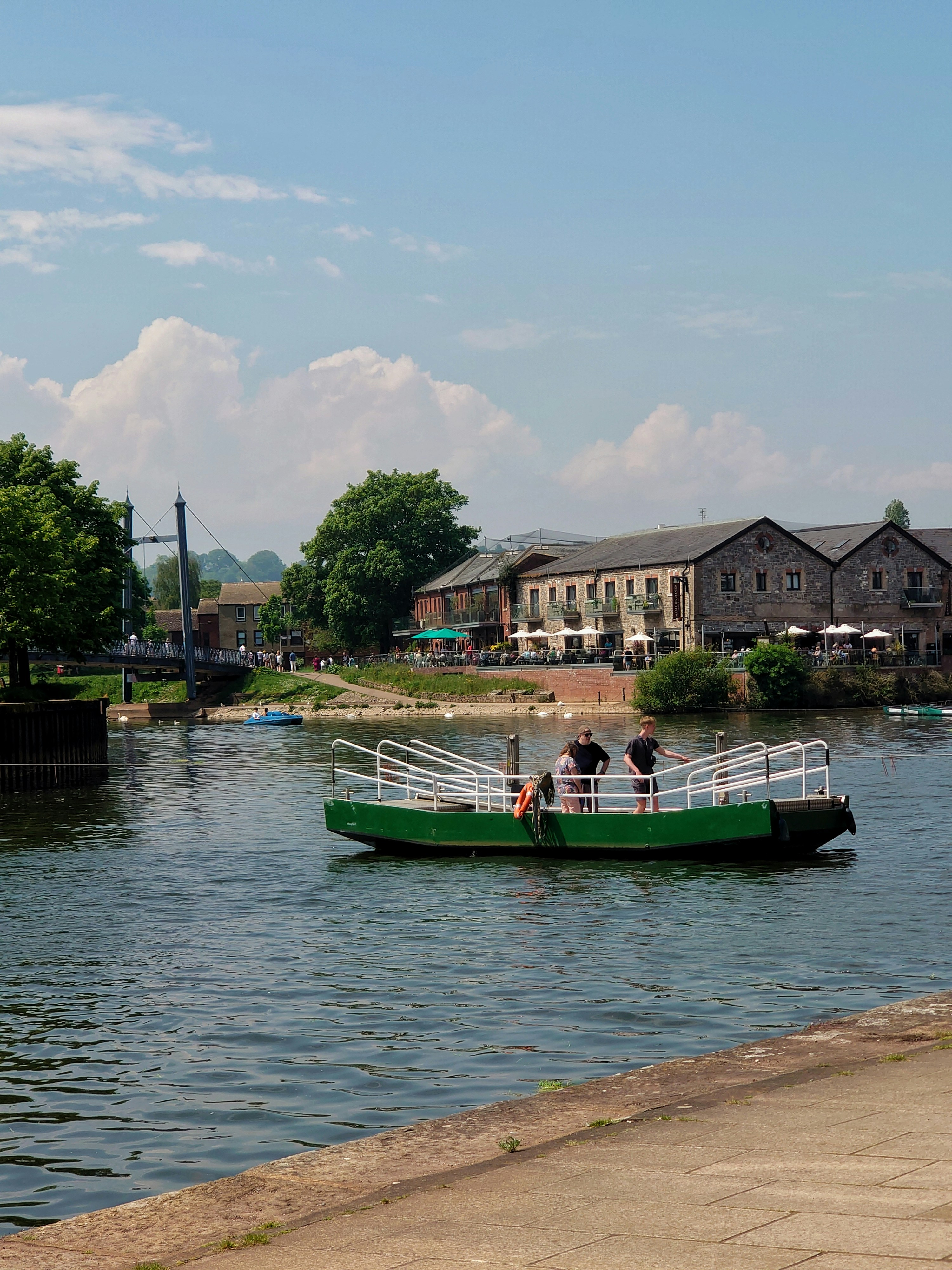 A green boat floating on top of a river photo – Free Exeter Image on ...