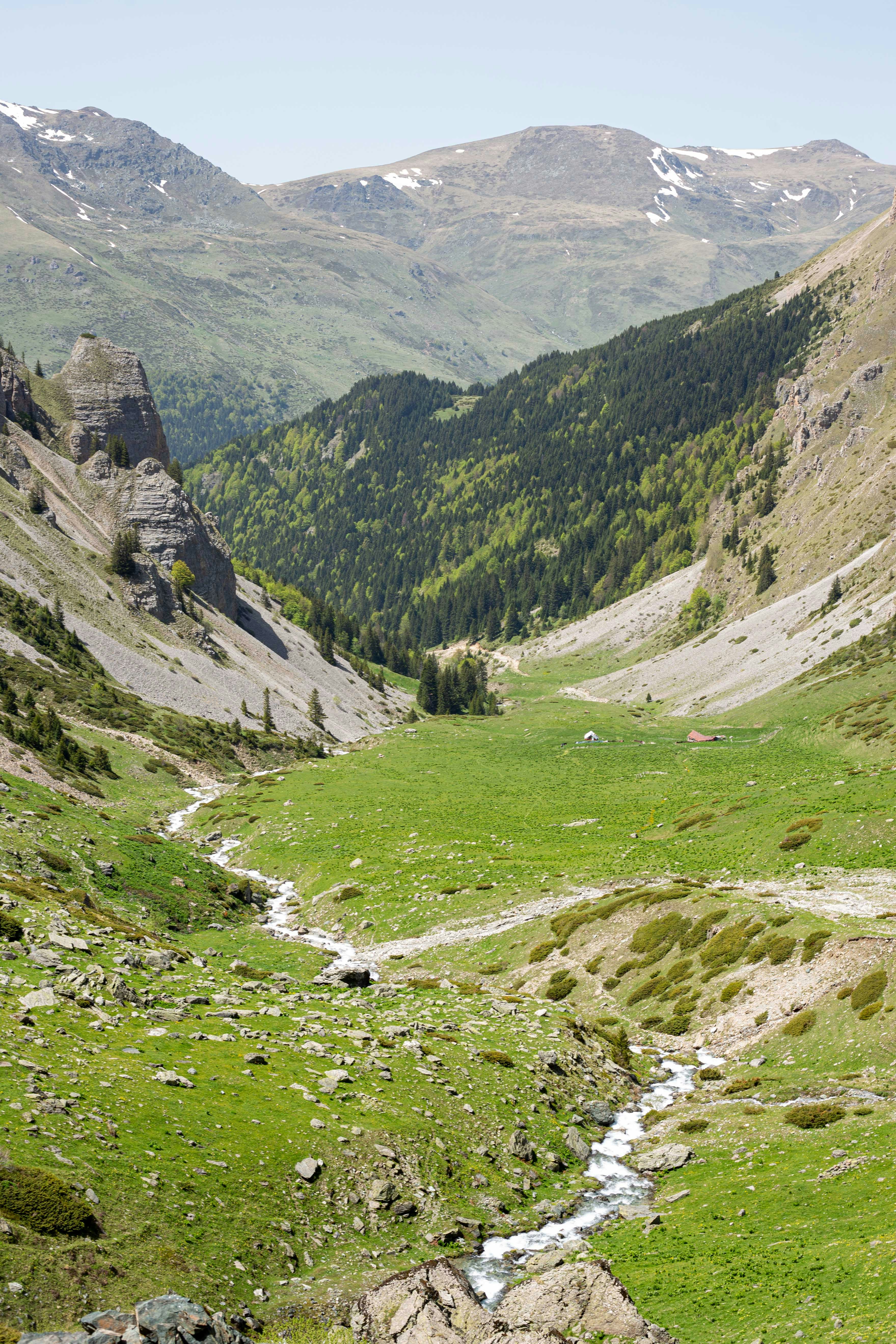 A mountain valley with a stream running through it photo – Free Šar ...