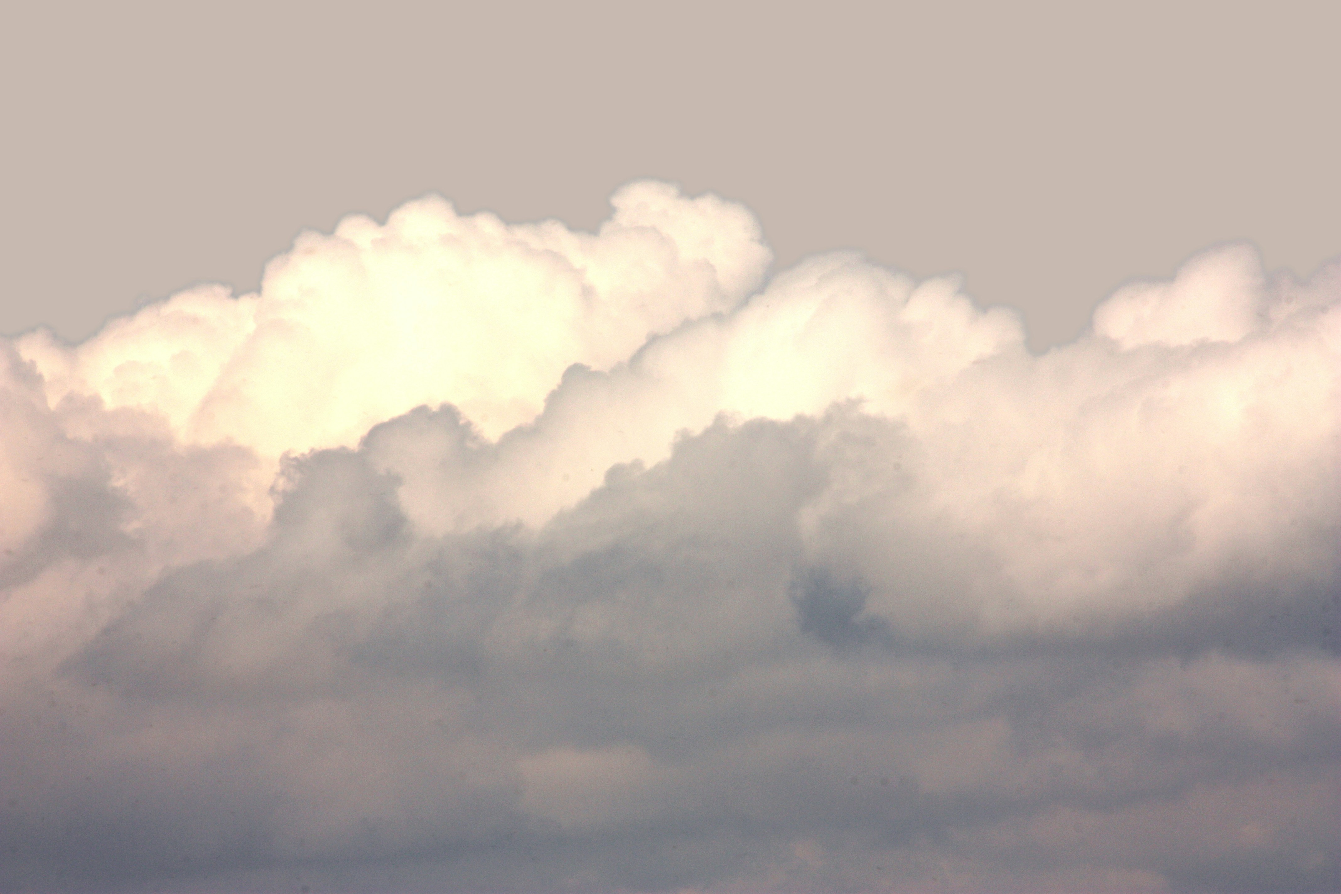 Peach-tinged Cumulus Drift in a Serene Sky