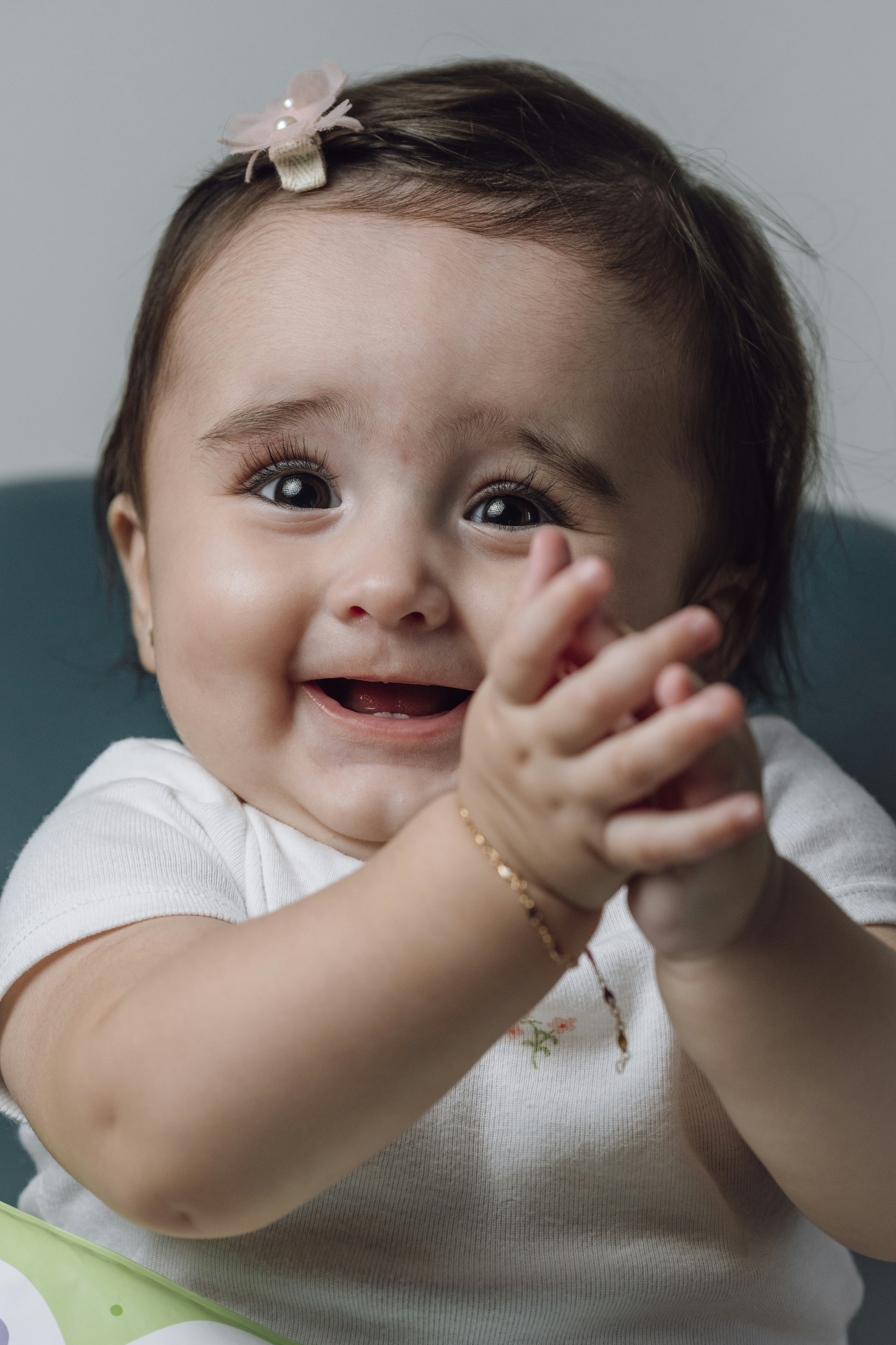A baby girl smiling and holding her hands together photo – Free Baby ...