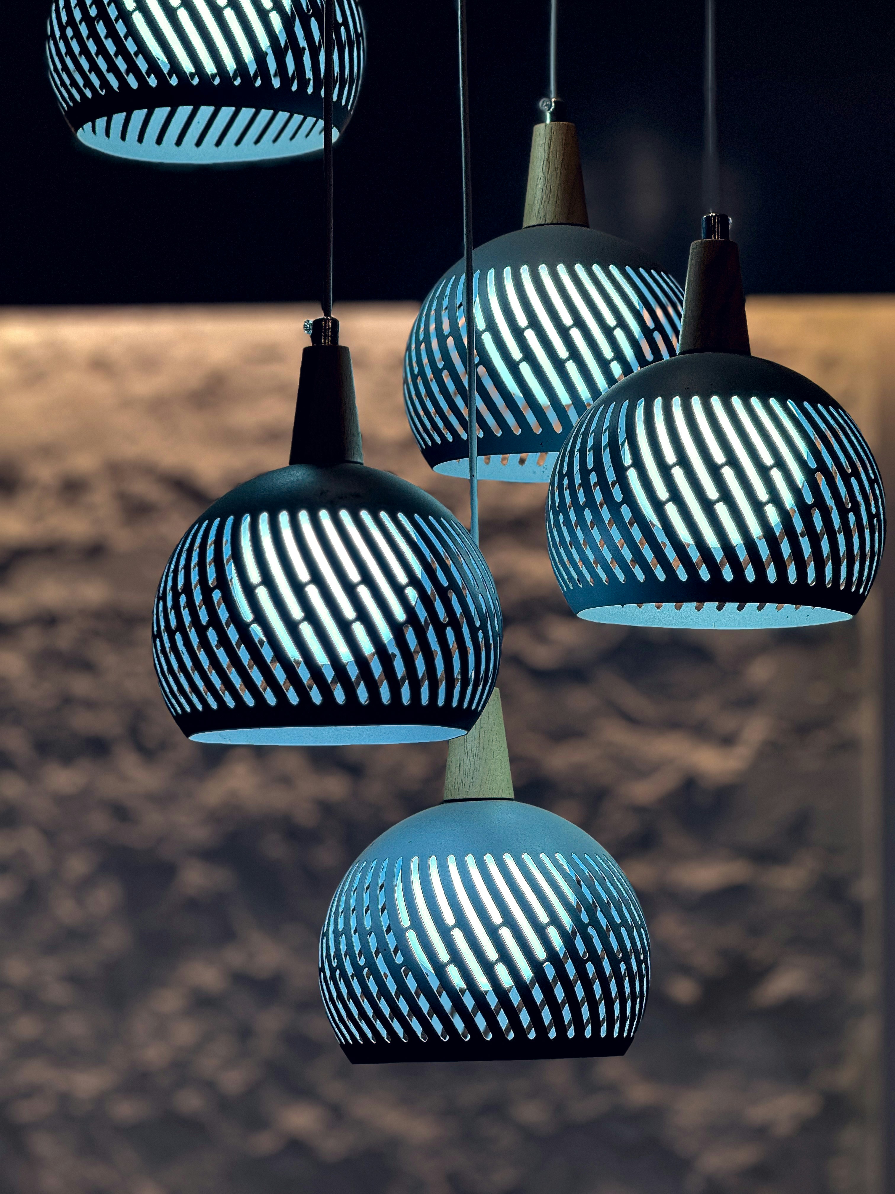 Blue Striped Pendant Orbs: A Quiet Quartet in Dim Ambient Light