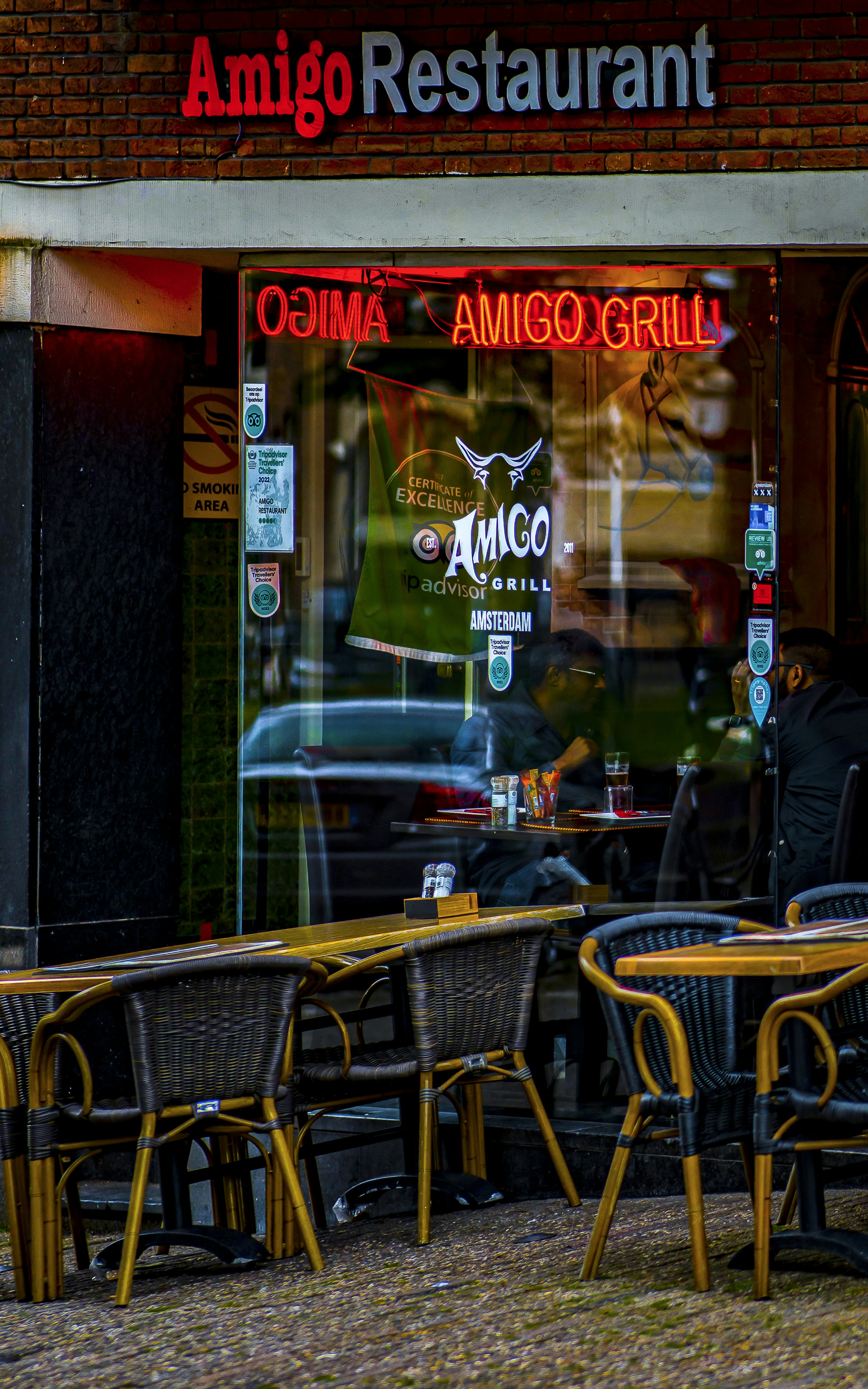 Neon Sign and Café Windows: Amigo Grill Evening Scene