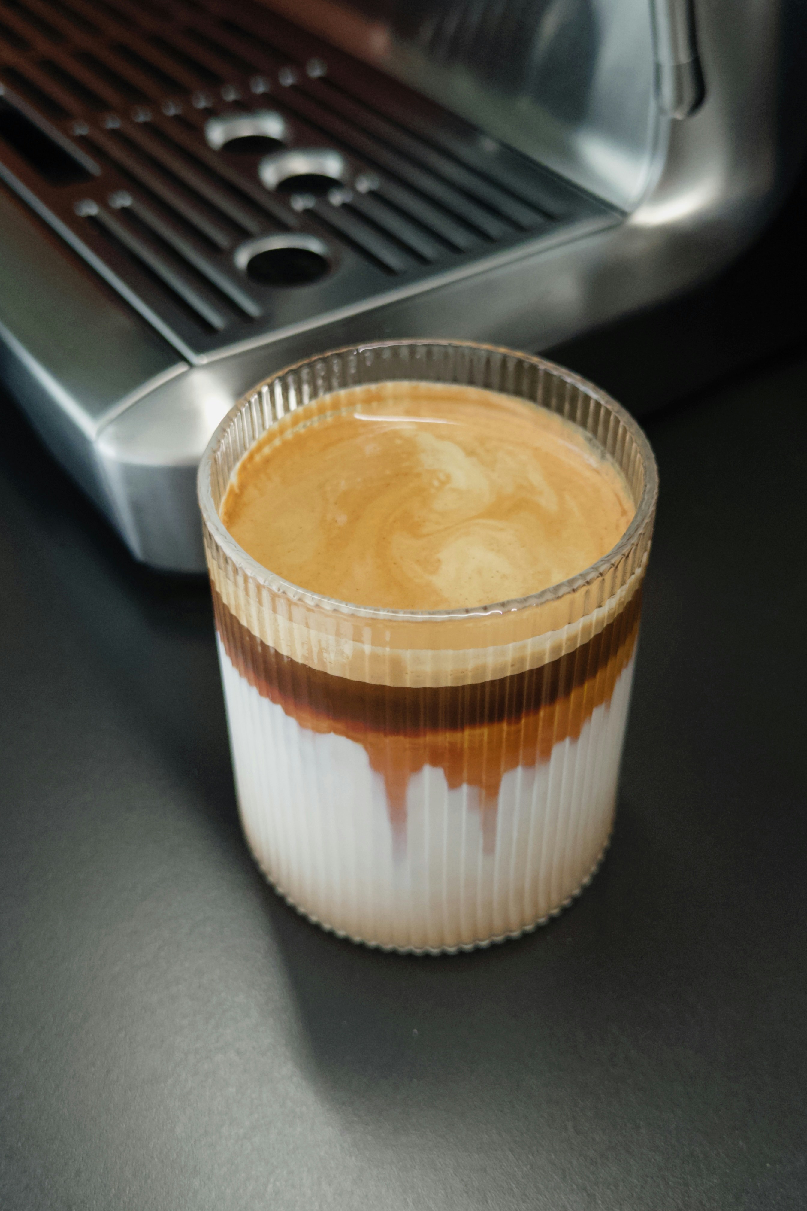 Caramel Crema Portrait: Layered Coffee in a Ribbed Glass