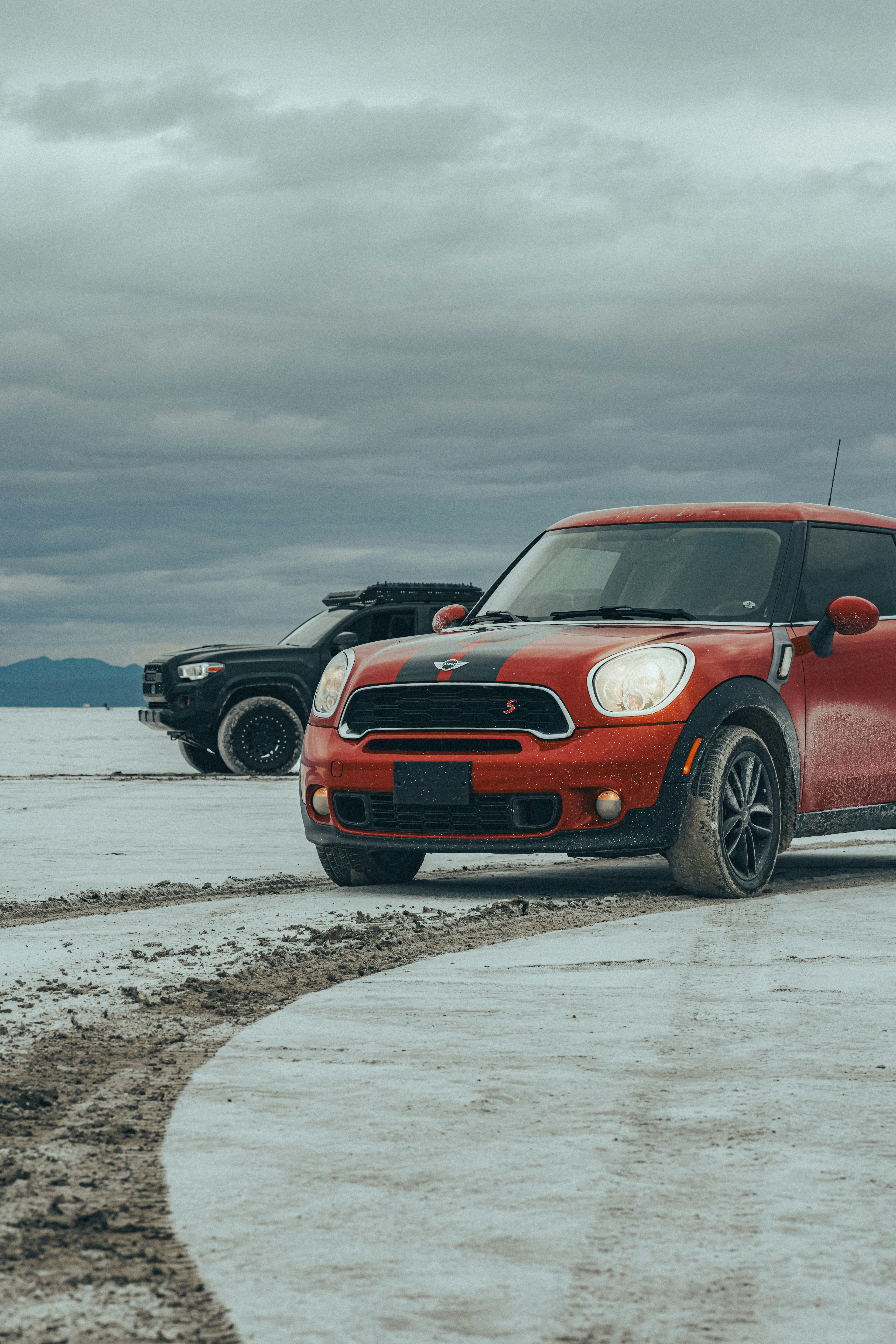 A small red car parked on a wet road photo – Free Automobile Image on ...