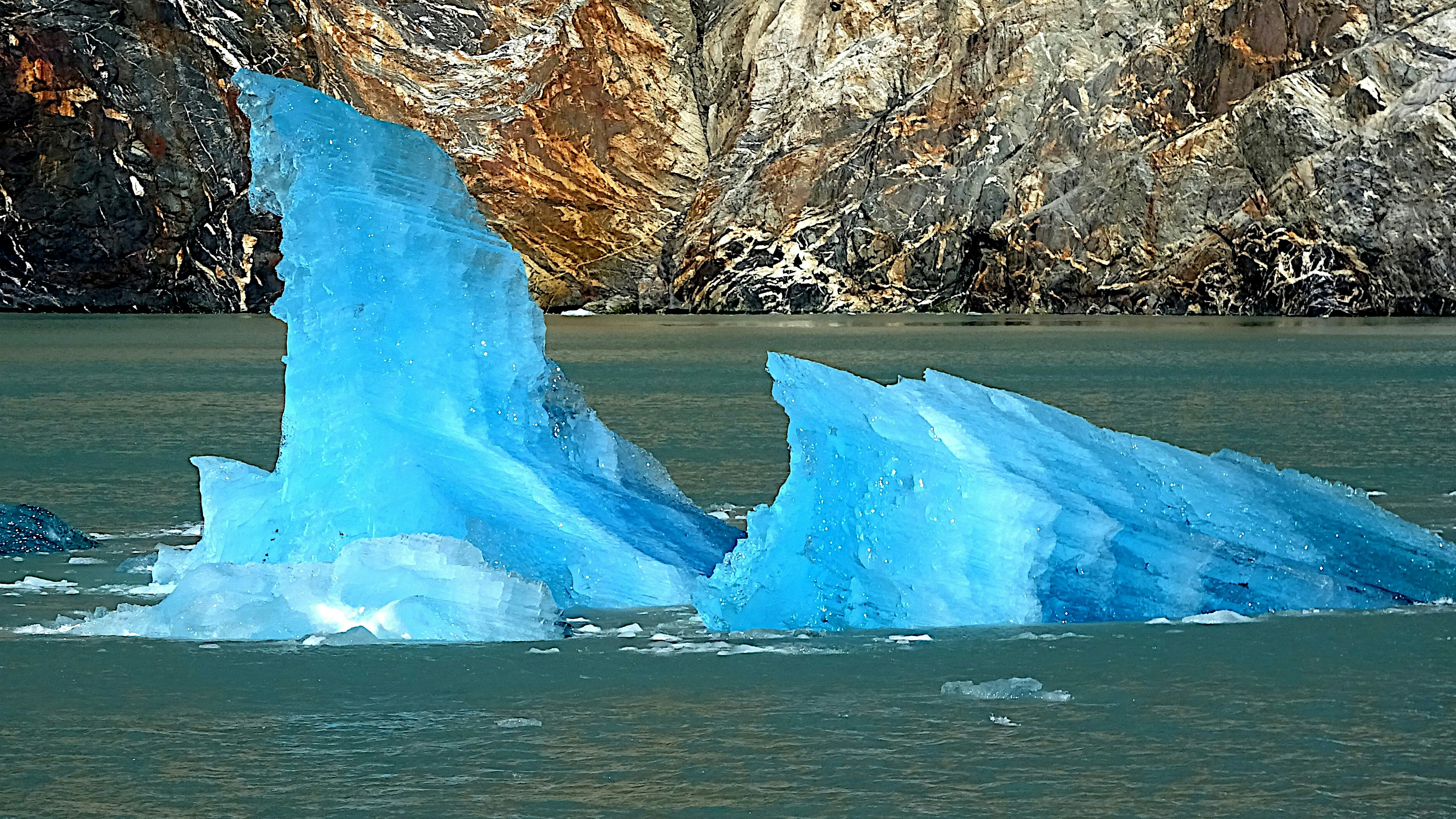 Arctic Symphony: Iceberg's Dance Against the Rockface