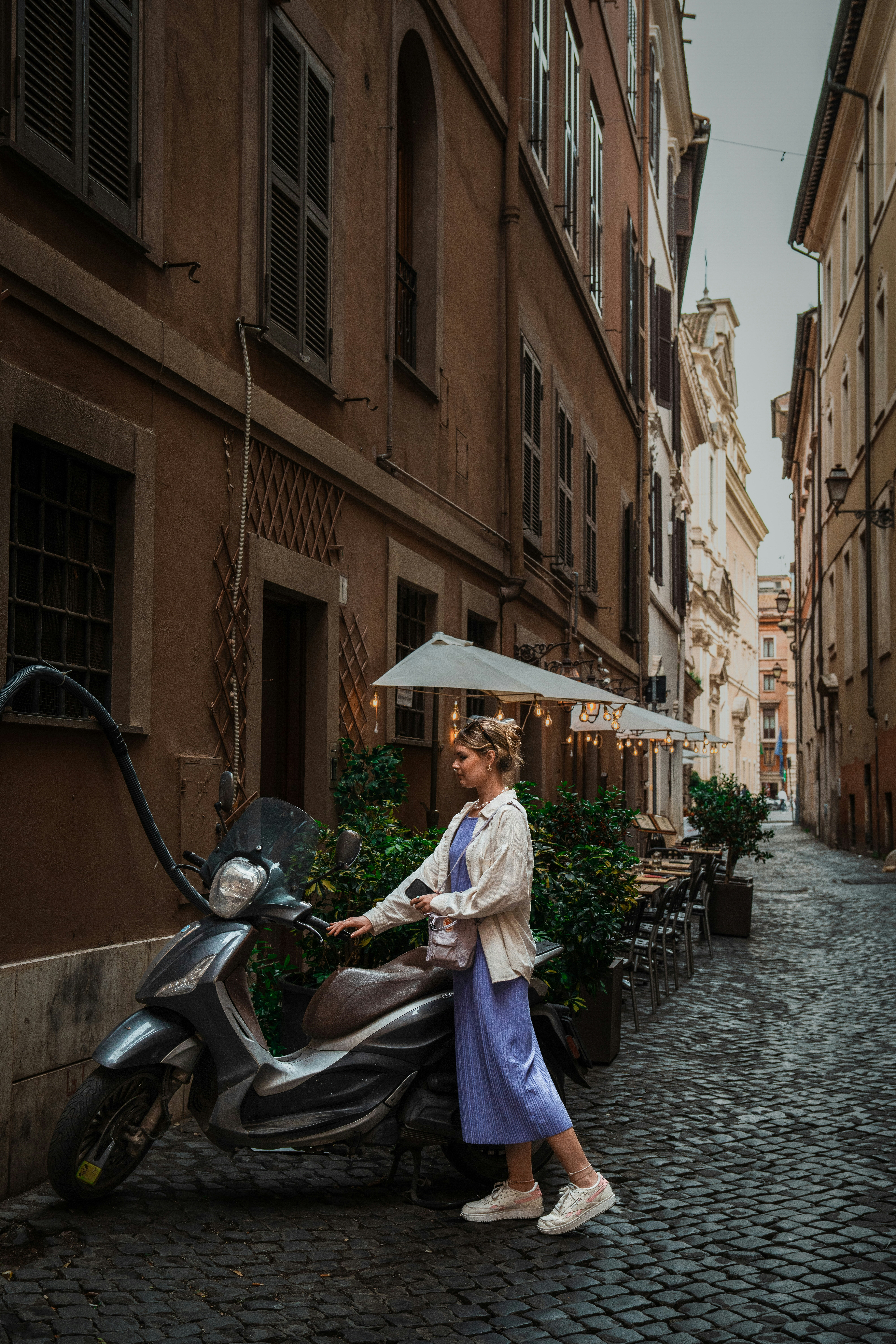 Cobbled Lane Strolling: A Quiet Moment by the Scooter