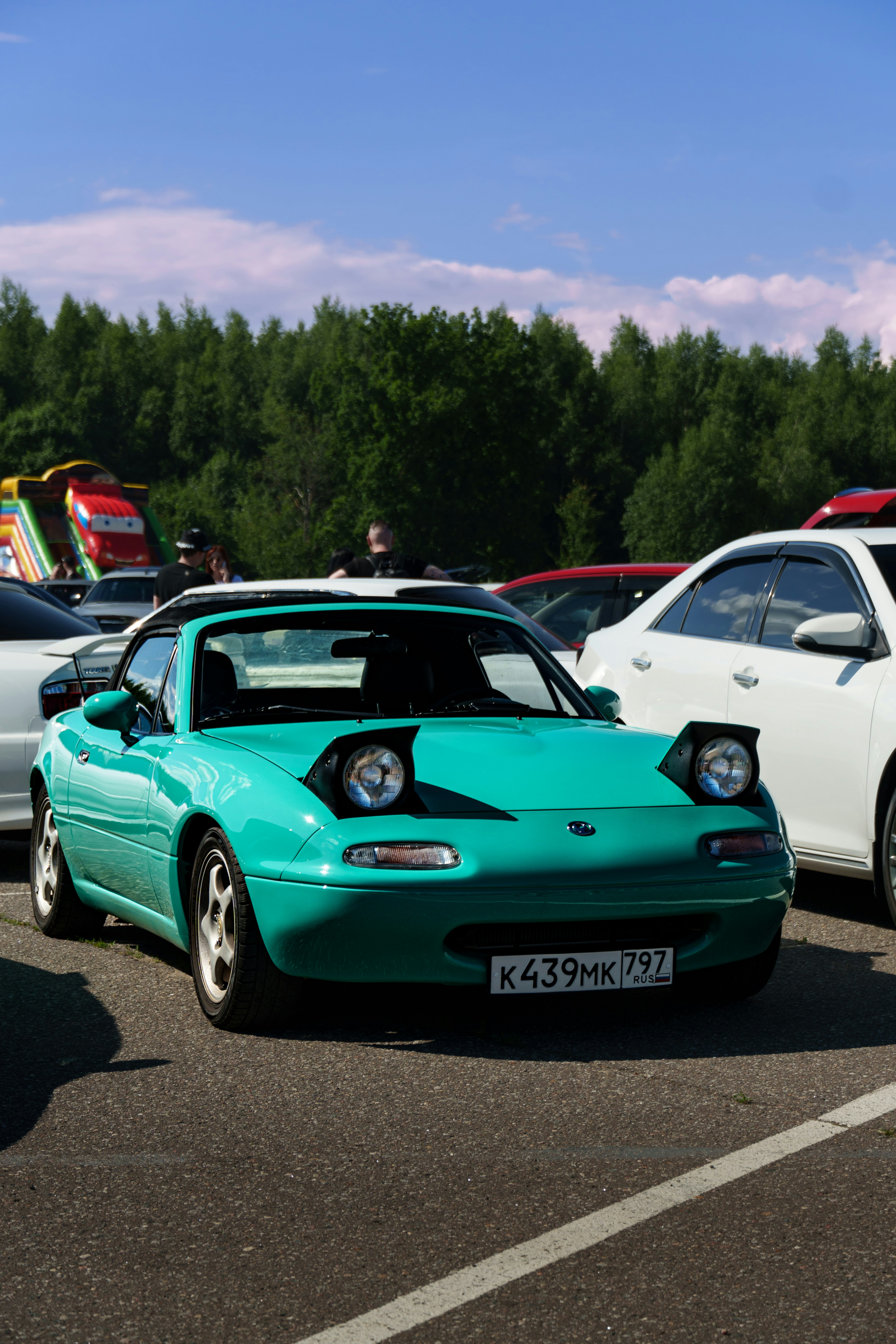 Pop-Up Teal MX-5 Holds Center Stage at a Sunlit Car Meet