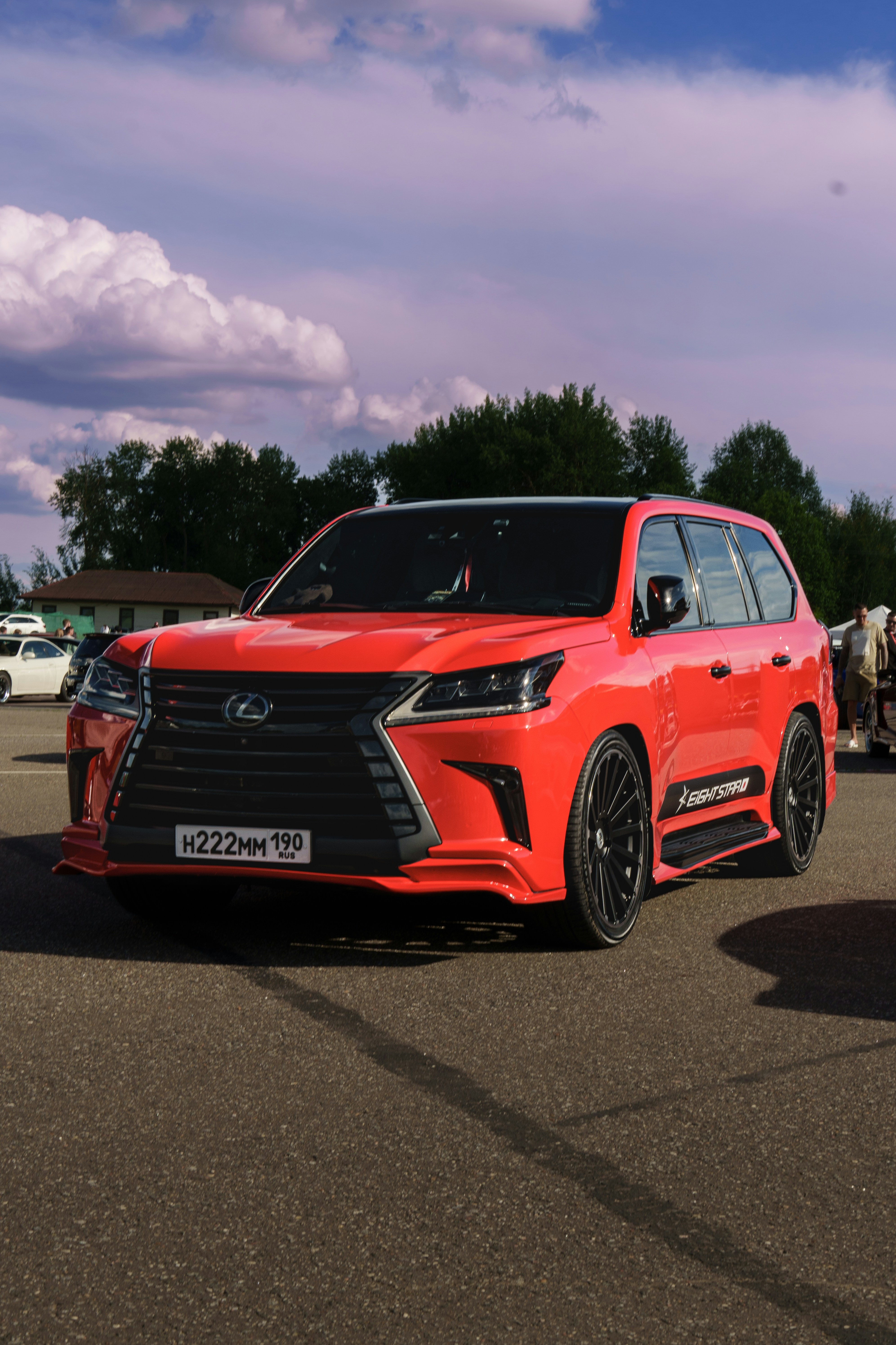 Crimson Lexus SUV Dominates a Weekend Car Meet Under Expansive Clouds