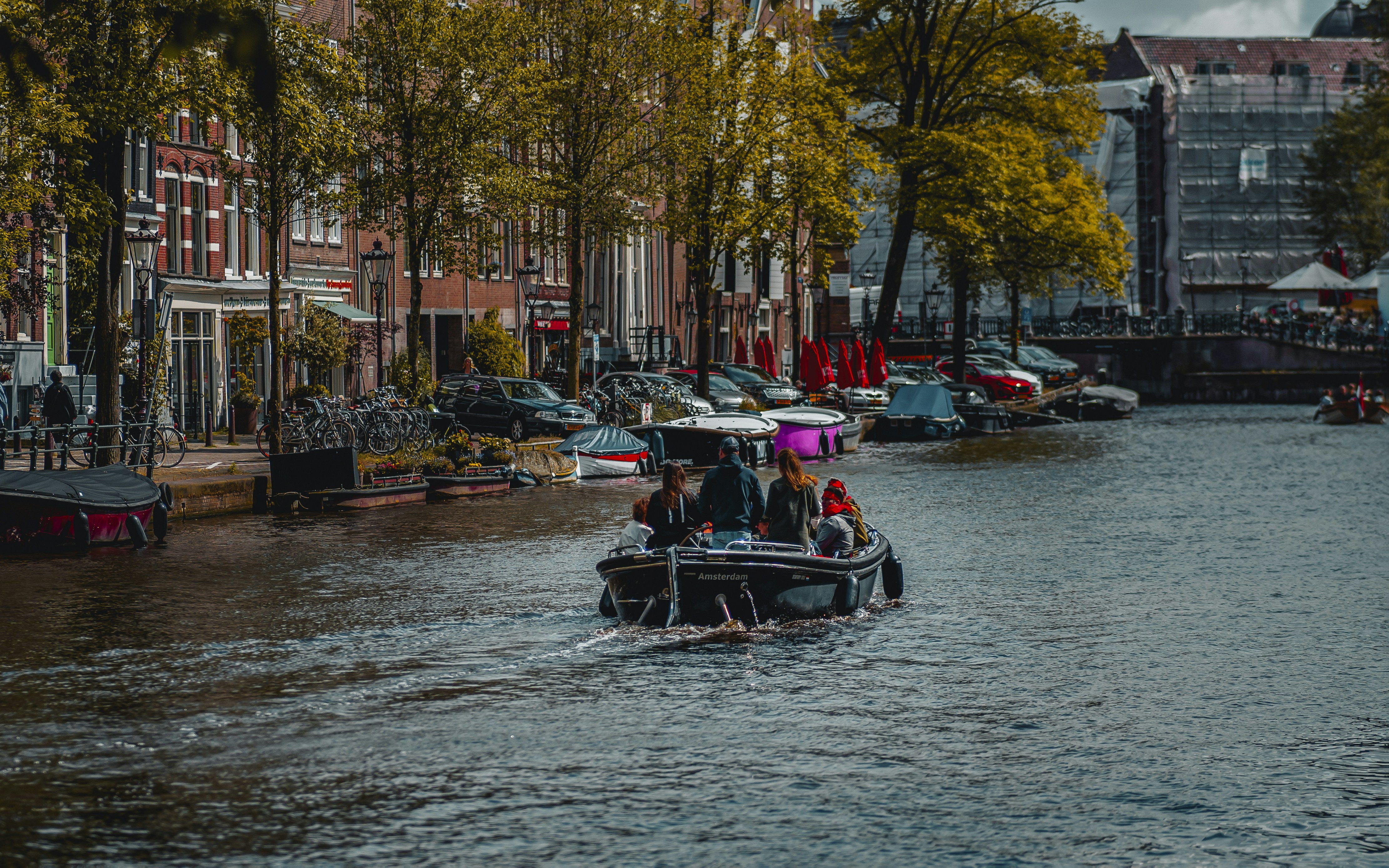 A group of people riding in a boat down a flooded street photo – Free ...