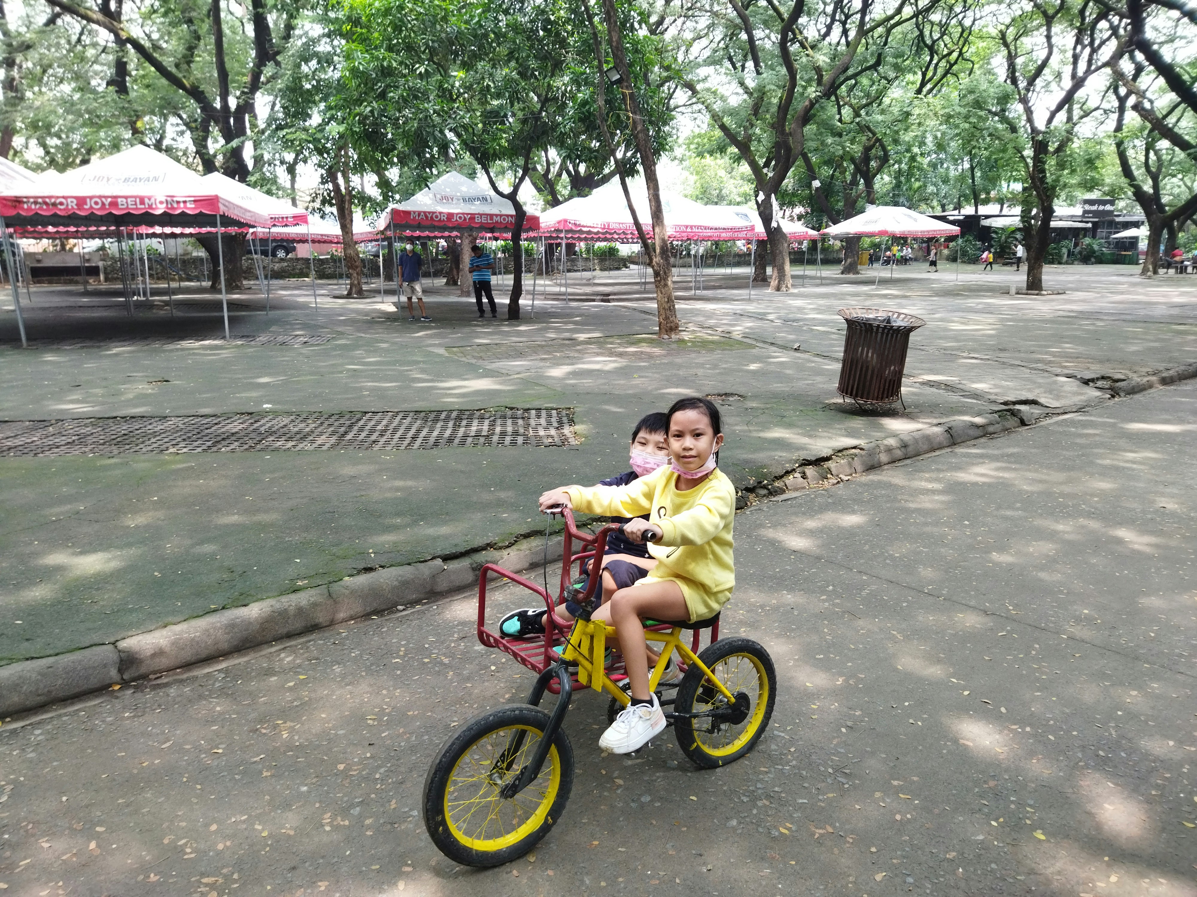 A young boy riding a bike in a park