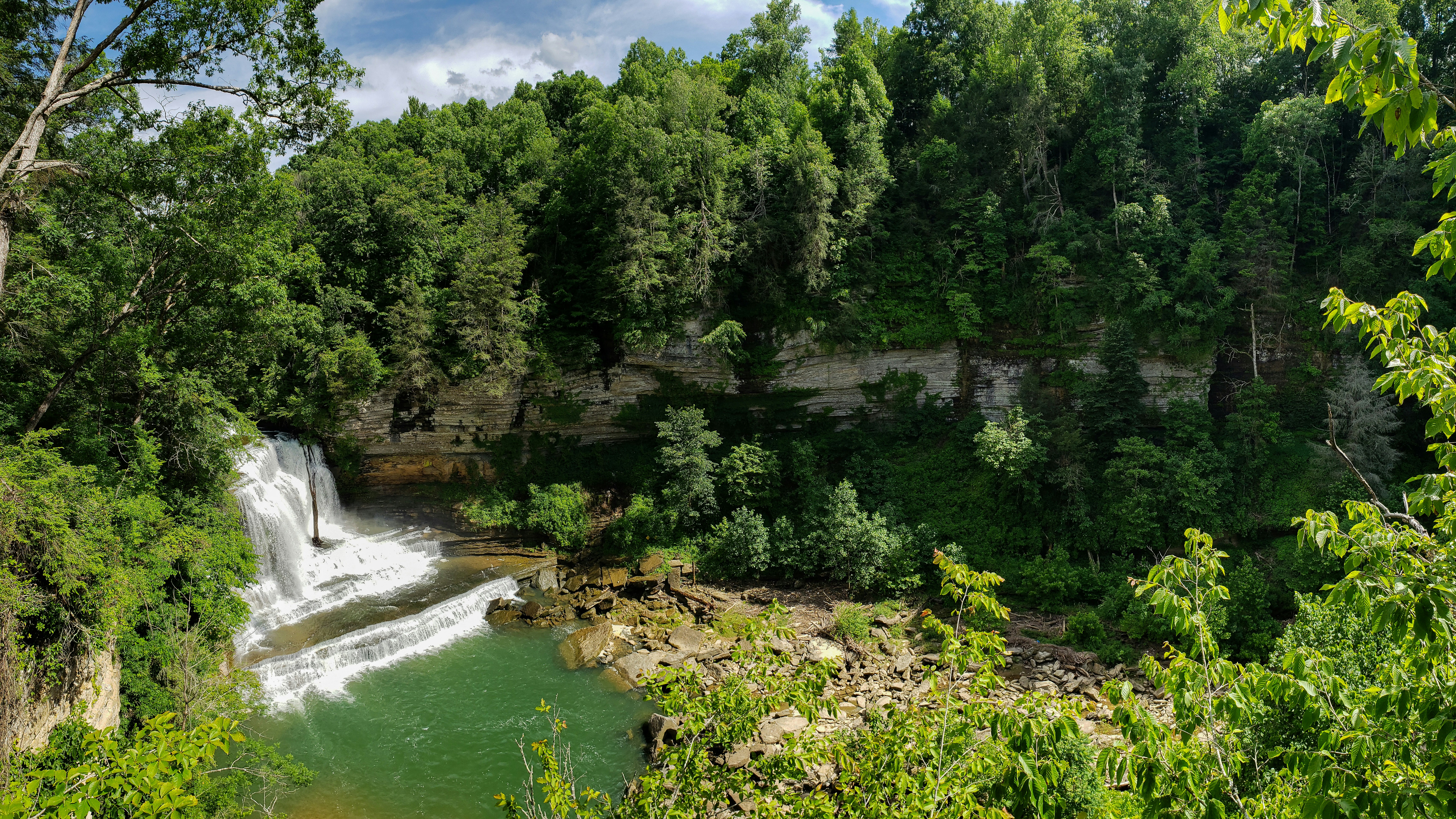 A large waterfall surrounded by trees and water photo – Free Waterfall ...