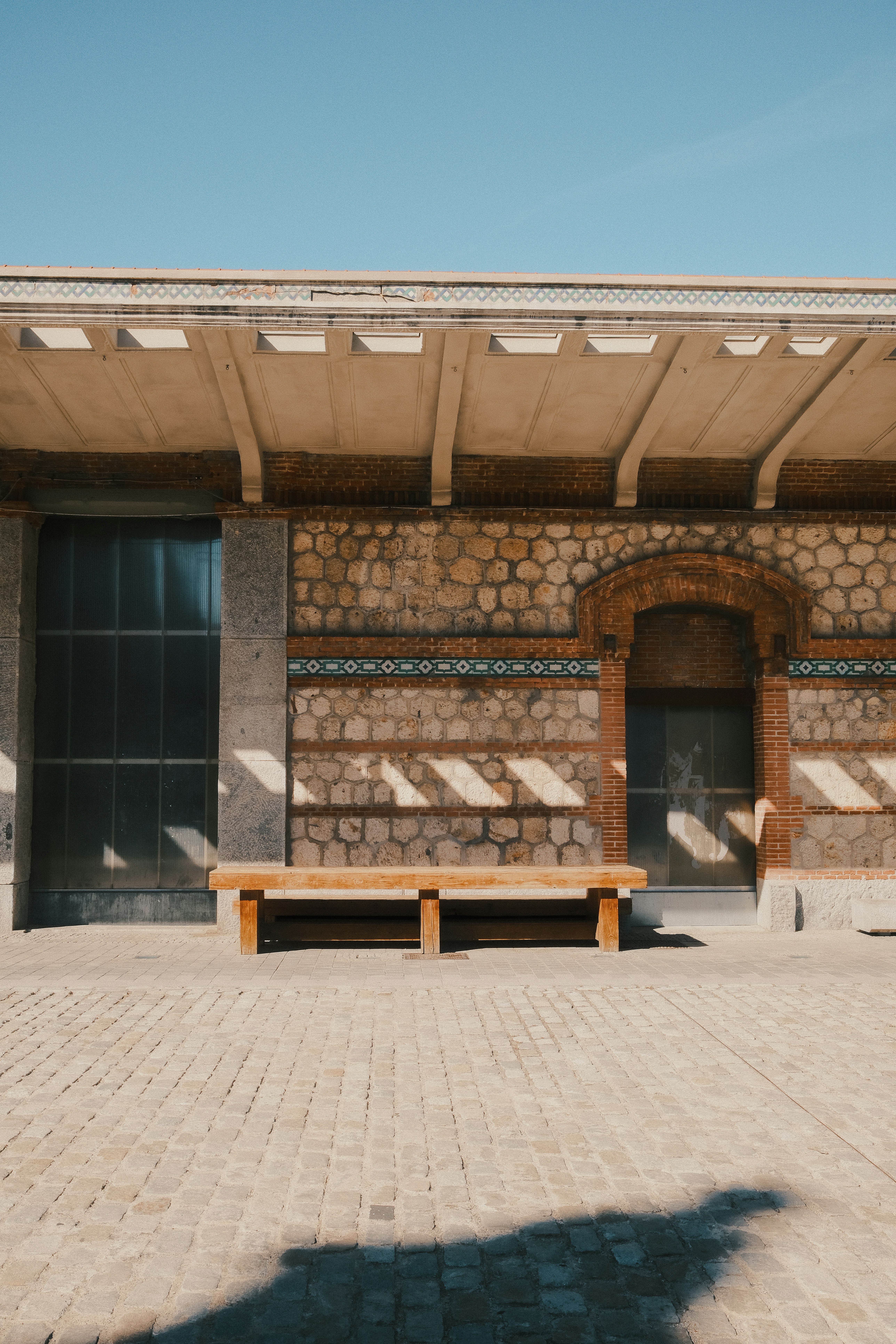 Sunlit Archway and Bench: A Quiet Courtyard Stone Narrative