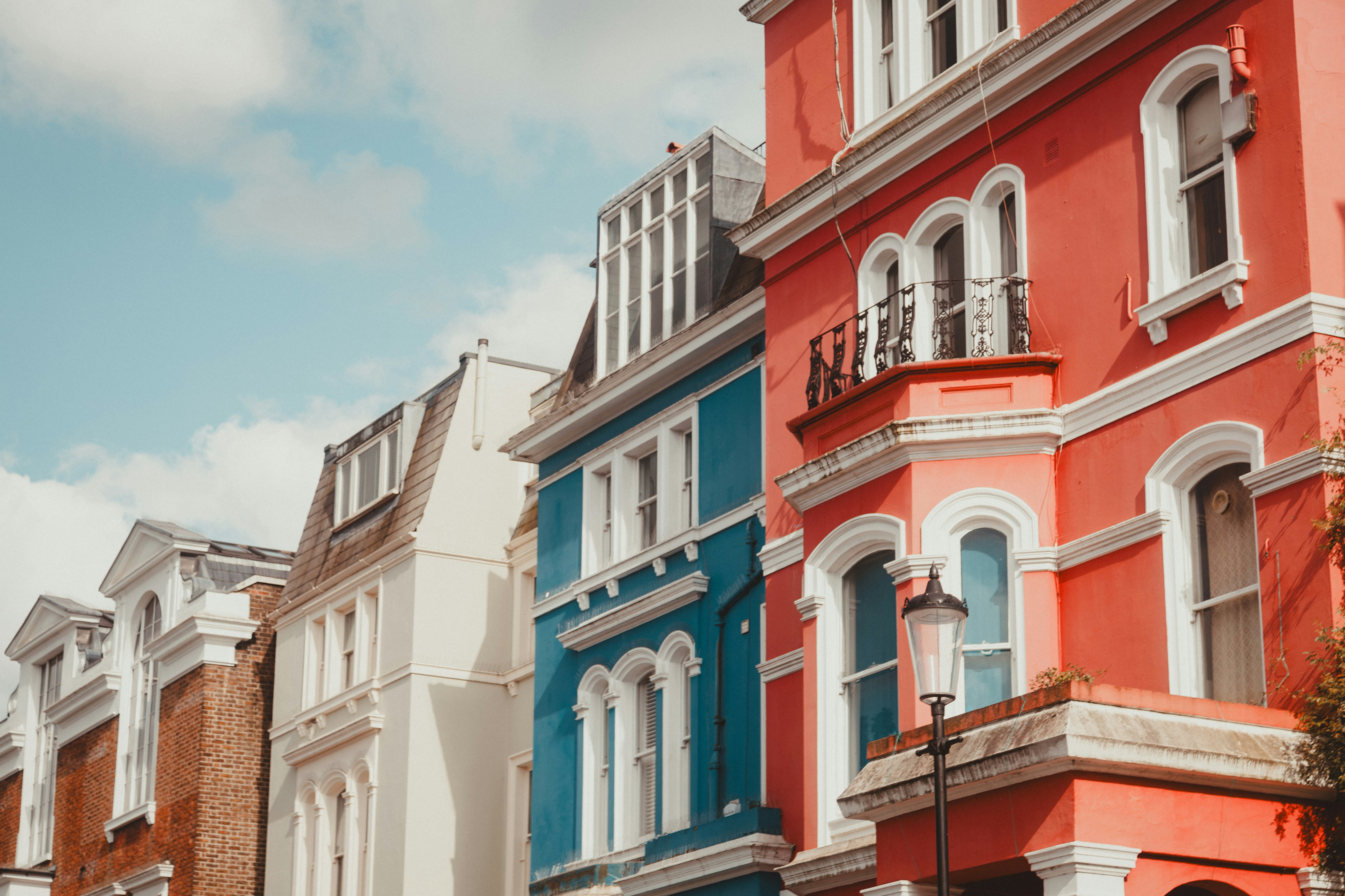 A row of multi - colored buildings on a city street photo – Free Uk ...