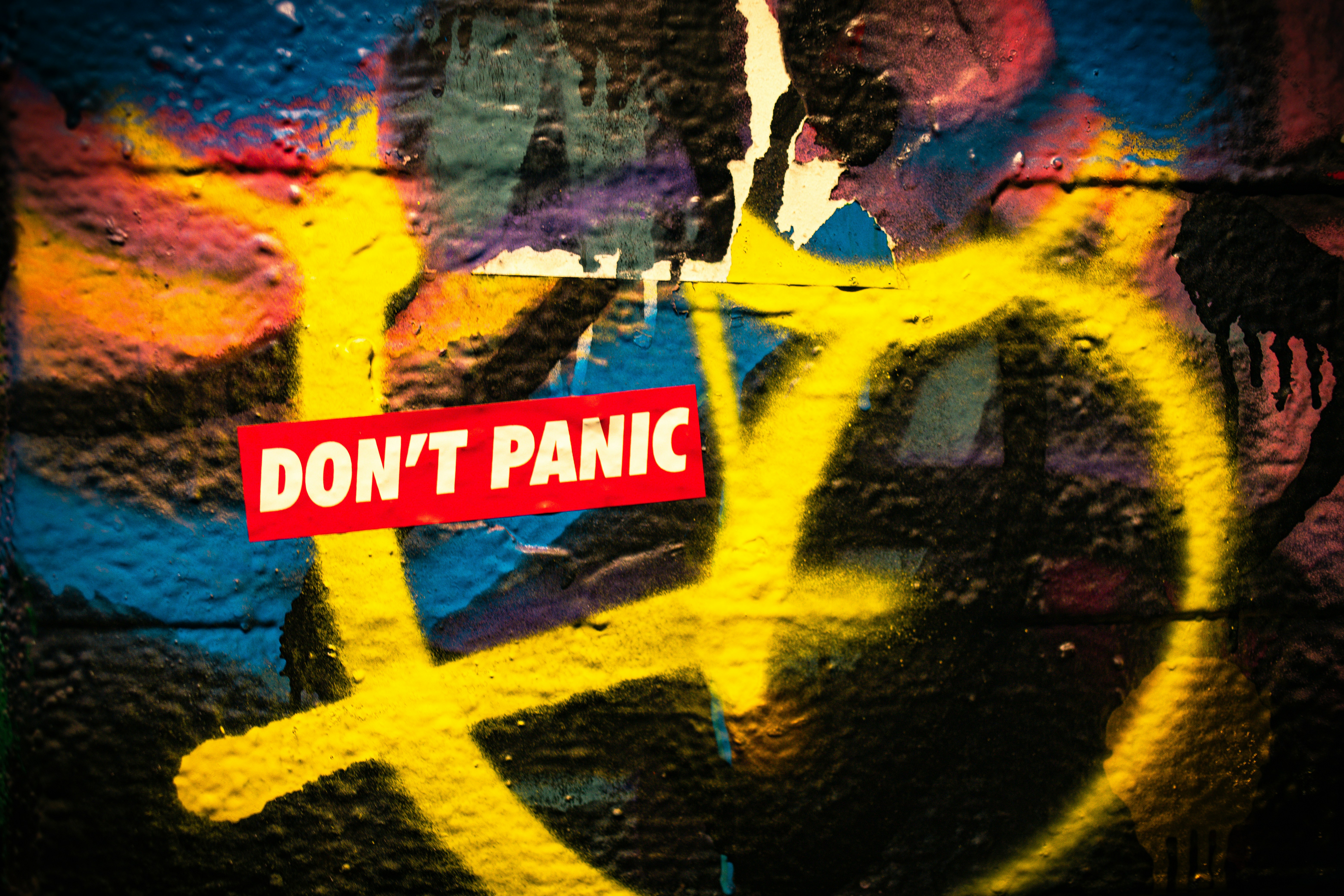 A graffiti wall with a don't panic sign on it photo – Free Sticker ...