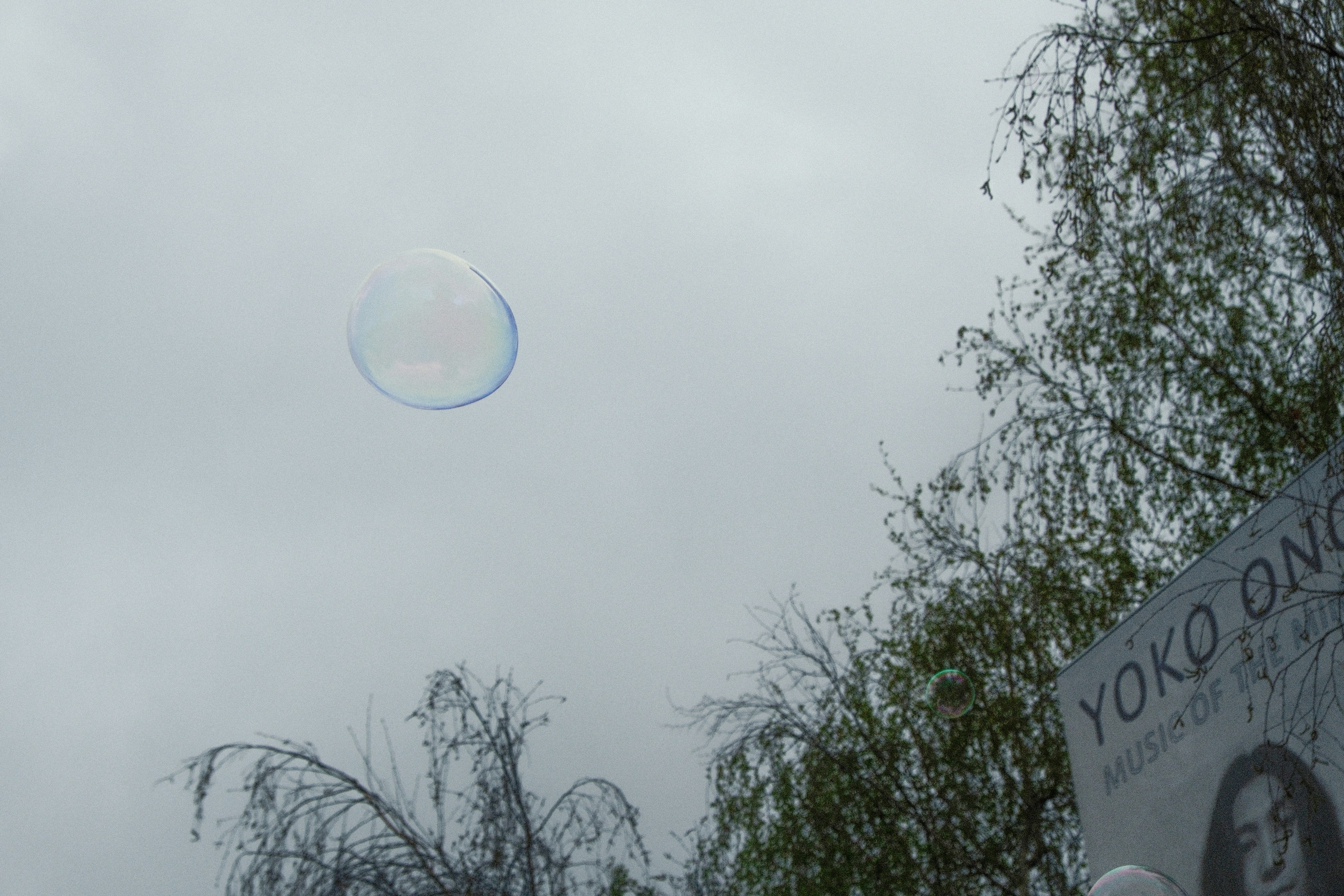 Bubble Above the Gray Skyline: a Quiet Moment by the Yoko Ono Billboard