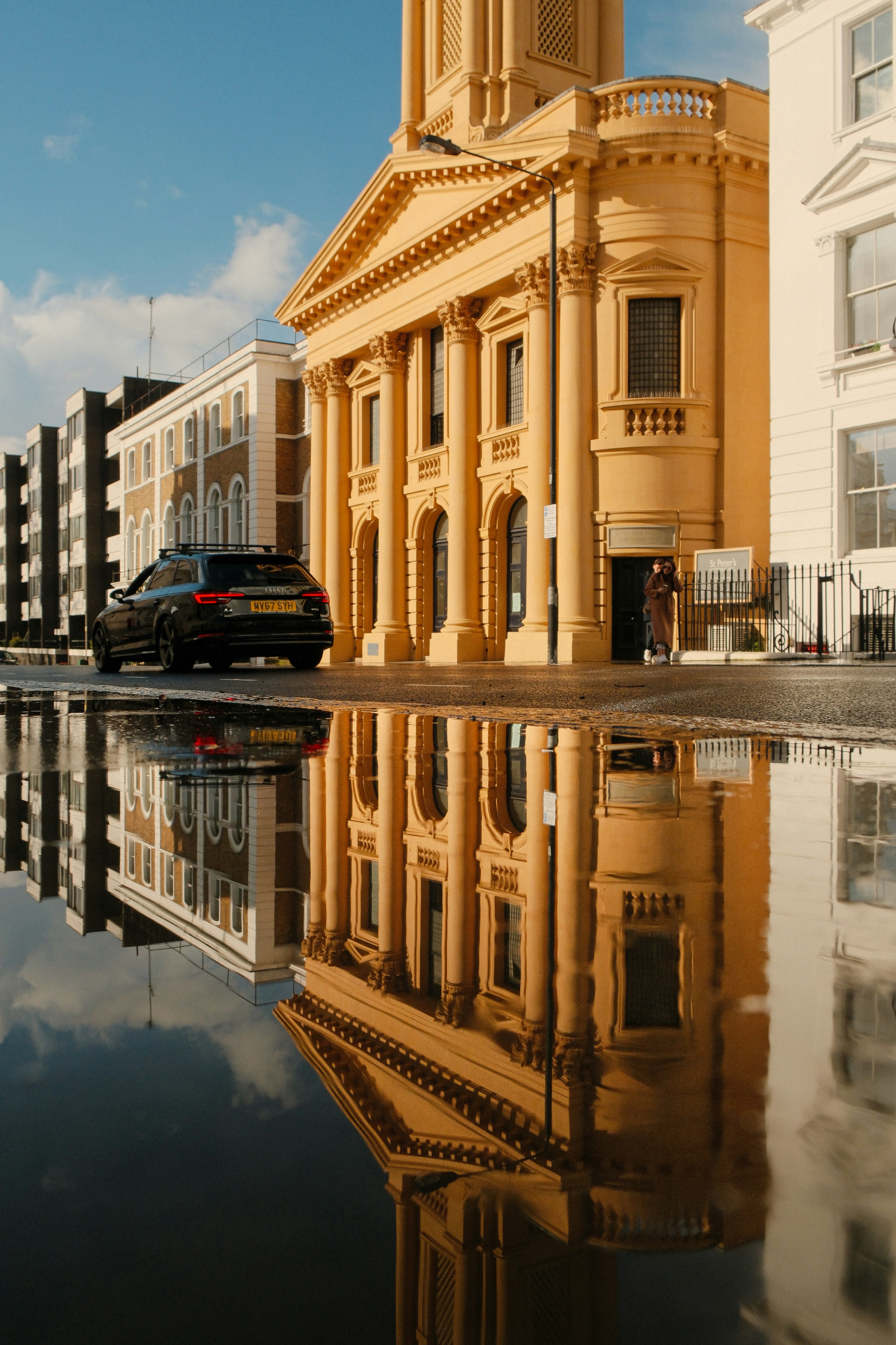 Golden Facade on a Wet Street: Echoes of Architecture