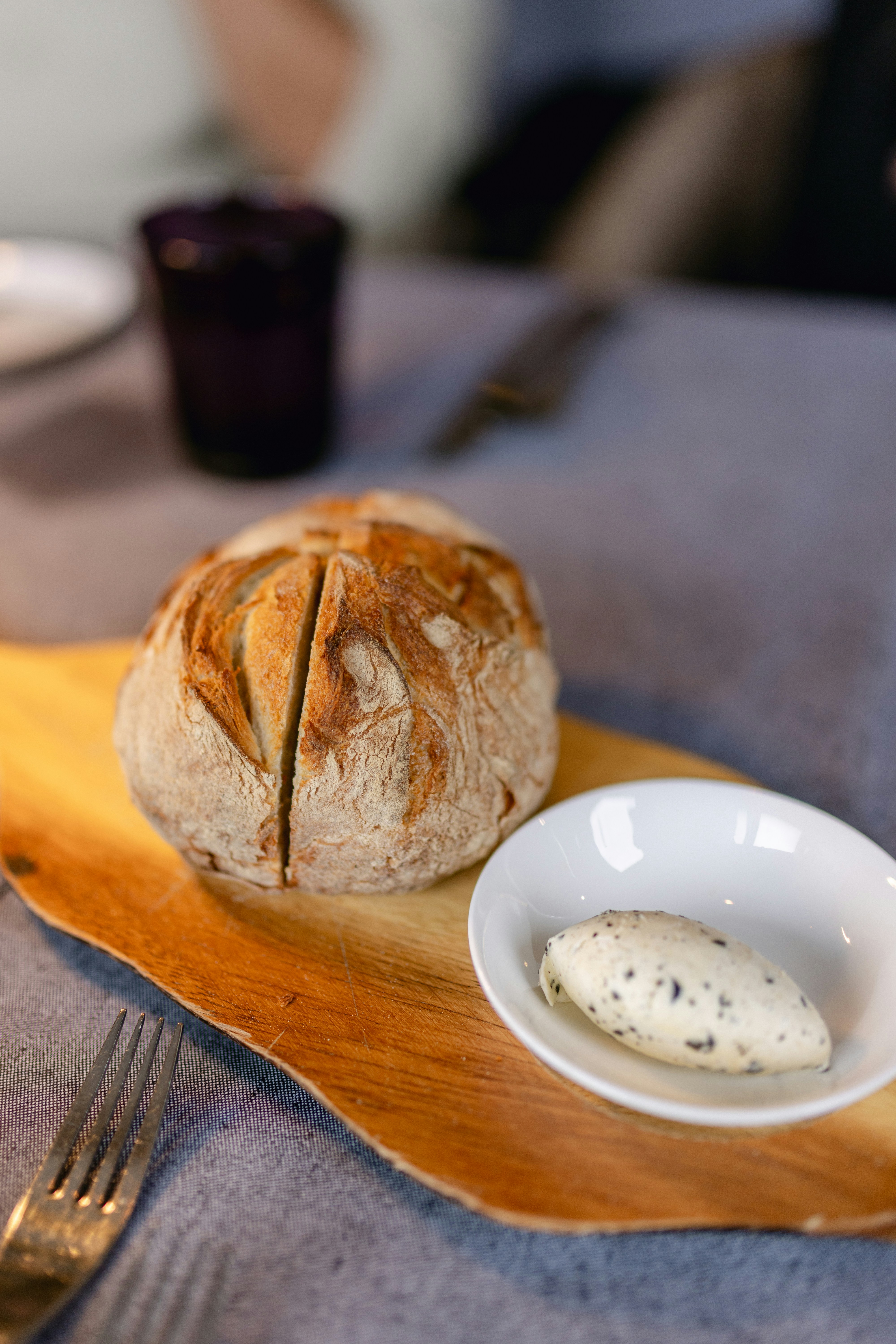 Crusty Round Loaf on a Wooden Board with a Creamy Dipping Sauce