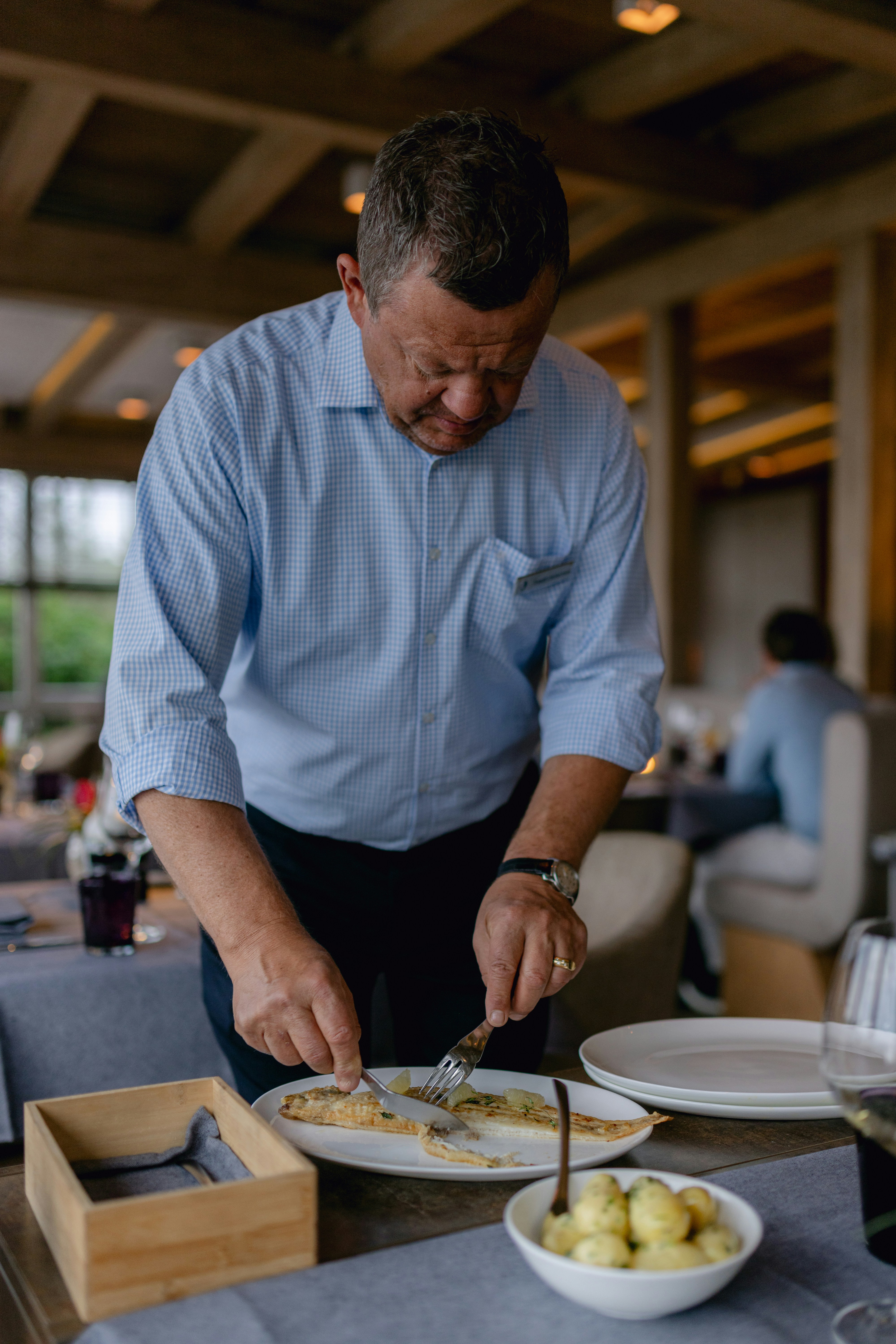 A Quiet Feast: The Chef at Work in a Softly Lit Dining Hall