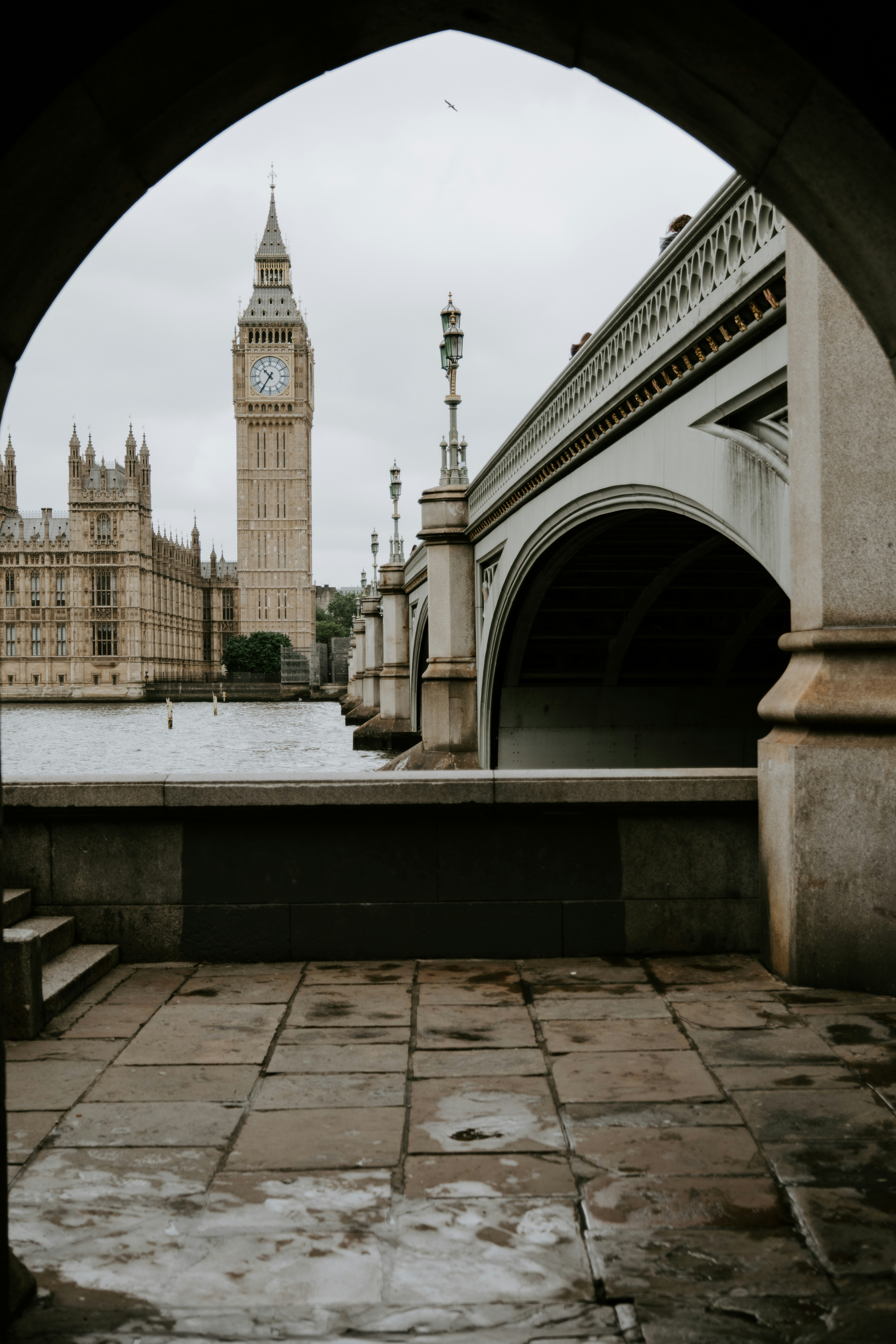 A view of a clock tower through an arch photo – Free Grey Image on Unsplash