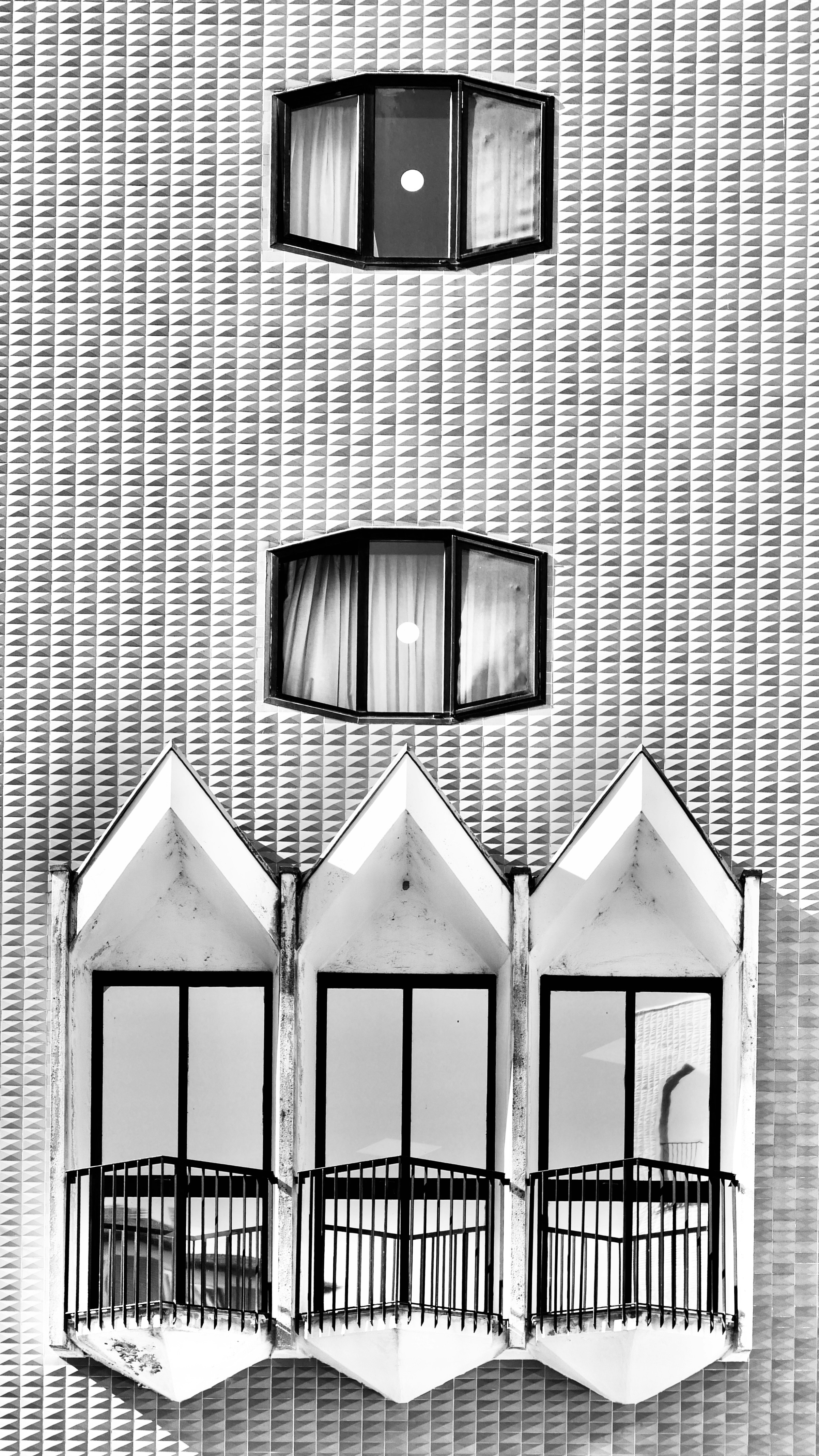 Monochrome Geometry: Diamond Facade with Triangular Balconies